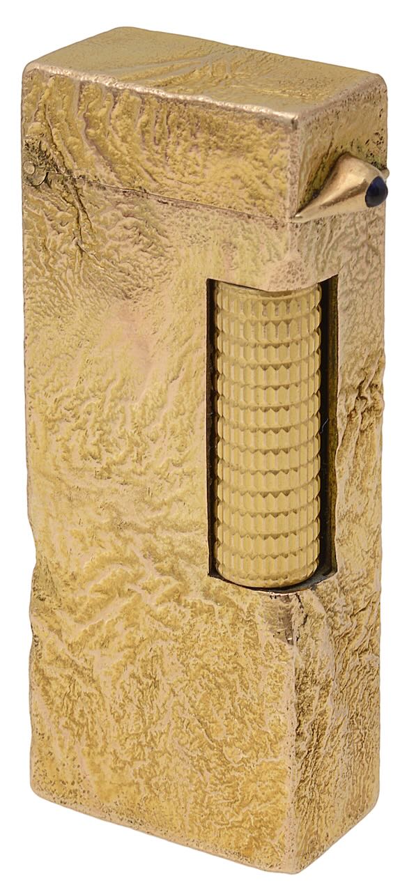 A 9ct gold mounted Dunhill 'Rollagas' lighter.With textured finish, in ...