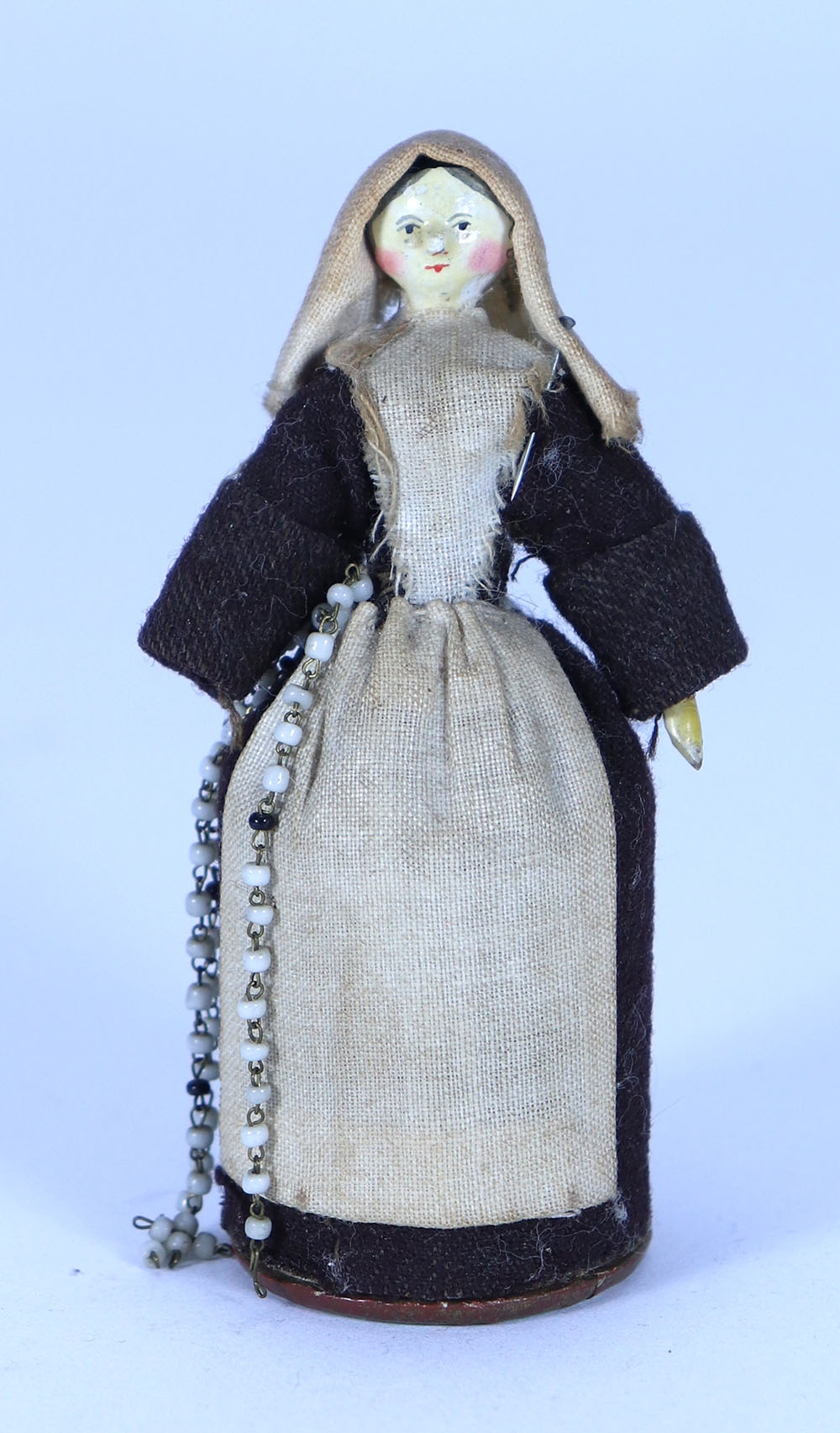 A sweet miniature painted wooden Grodnertal doll dressed as a Nun with ...
