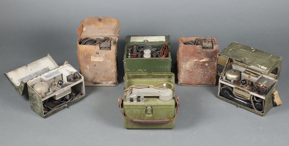 Five military field telephone sets and a power supply comprising two ...