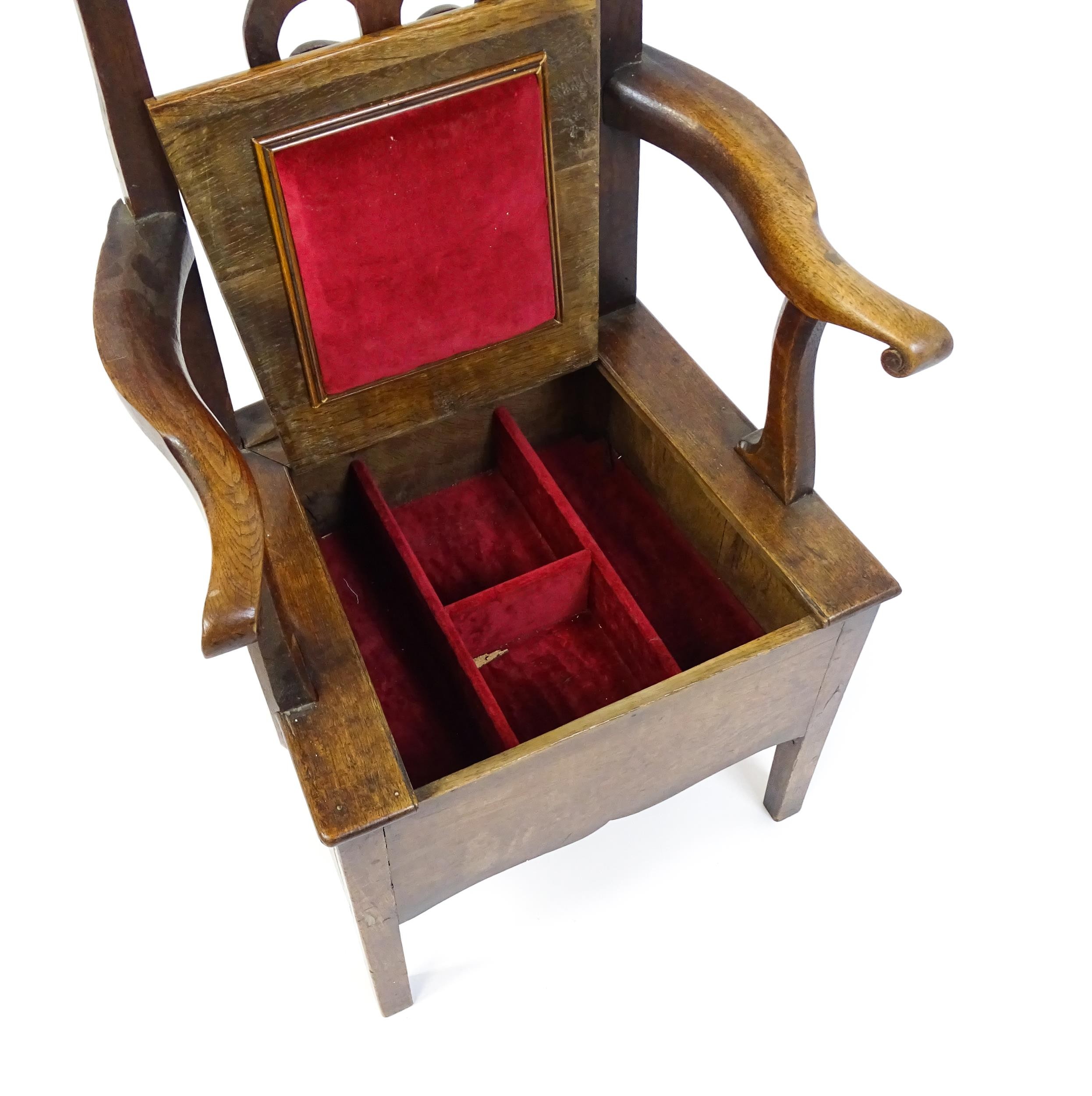 A late Georgian oak commode chair with a Chippendale style back splat ...