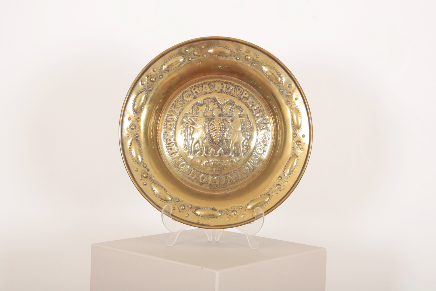 A "NUREMBURG" BRASS ALMS DISH DATED '1503' 19th century, the central ...