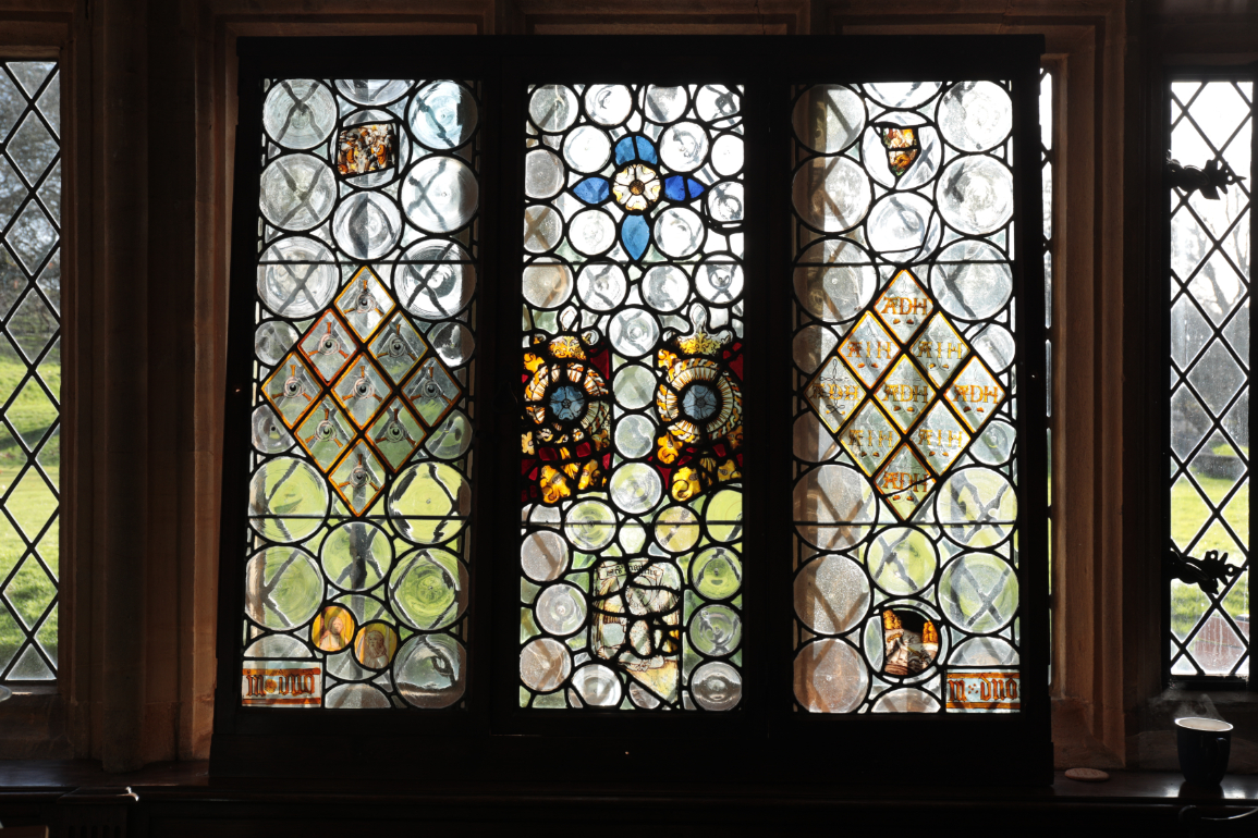 A LEADED LIGHT WINDOW in three sections, incorporating panels of ...