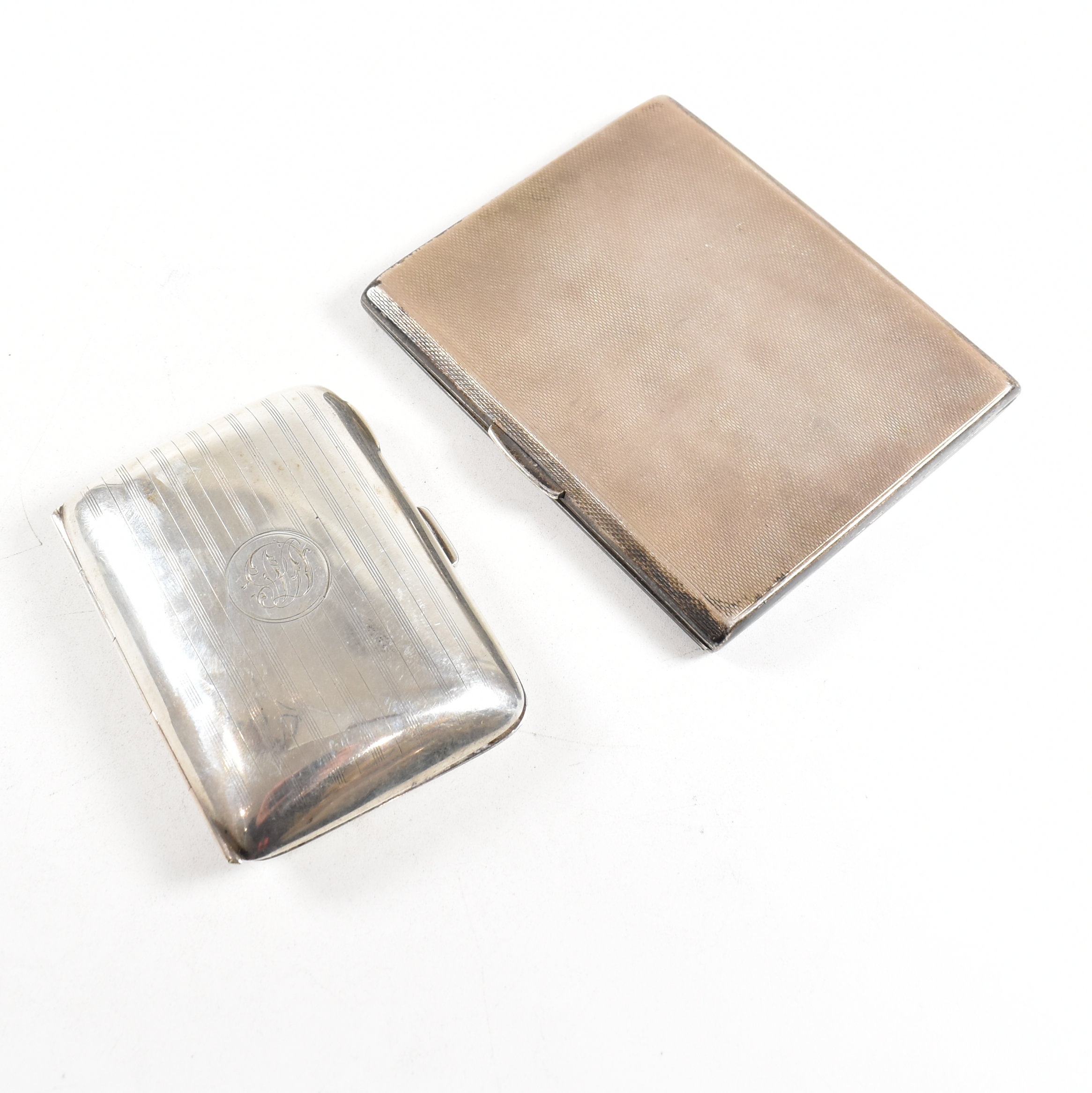 Two early 20th century hallmarked silver cigarette cases. The lot to ...