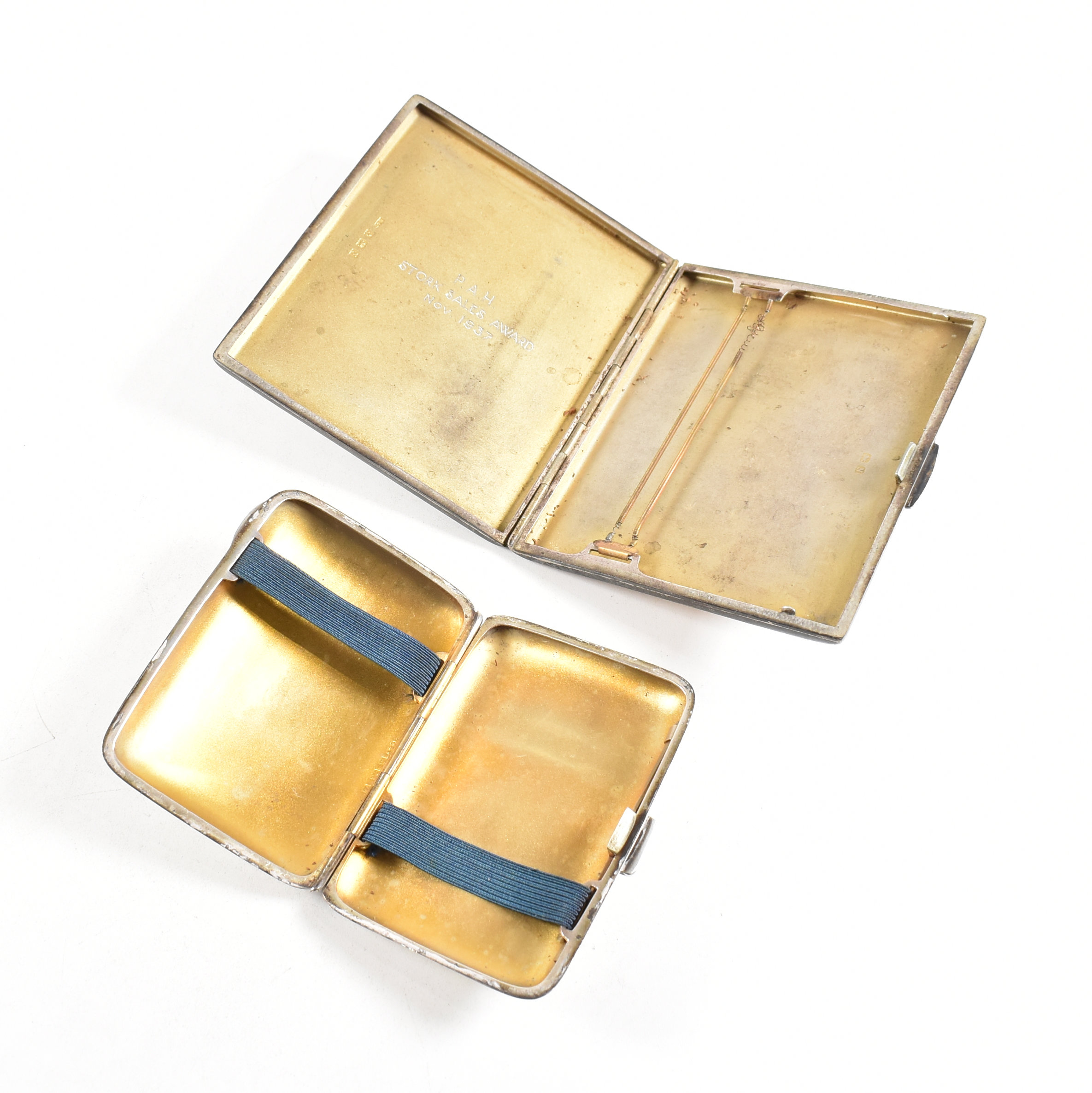 Two early 20th century hallmarked silver cigarette cases. The lot to ...