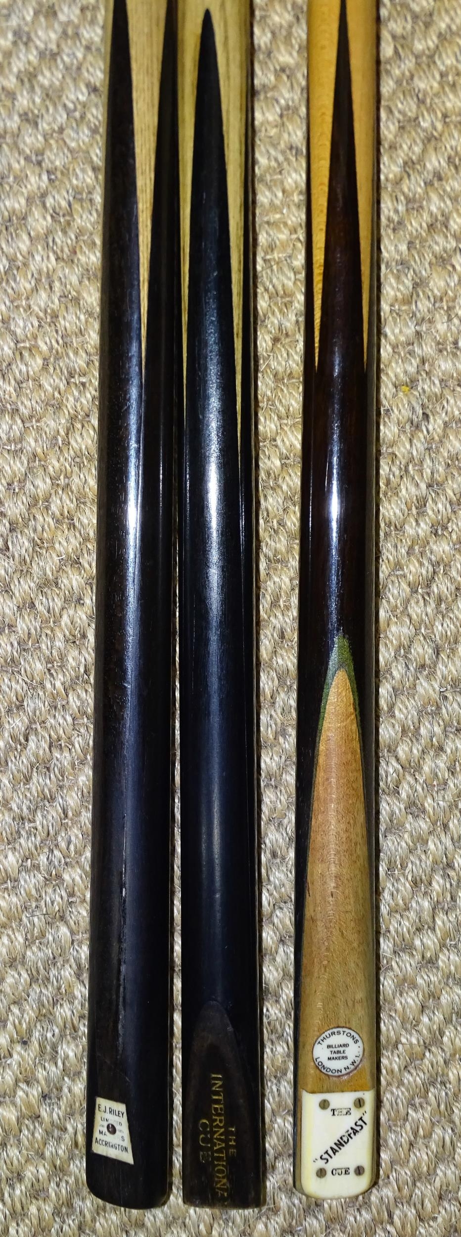 A collection of three snooker cues: a Riley Trapezium badge handmade ...