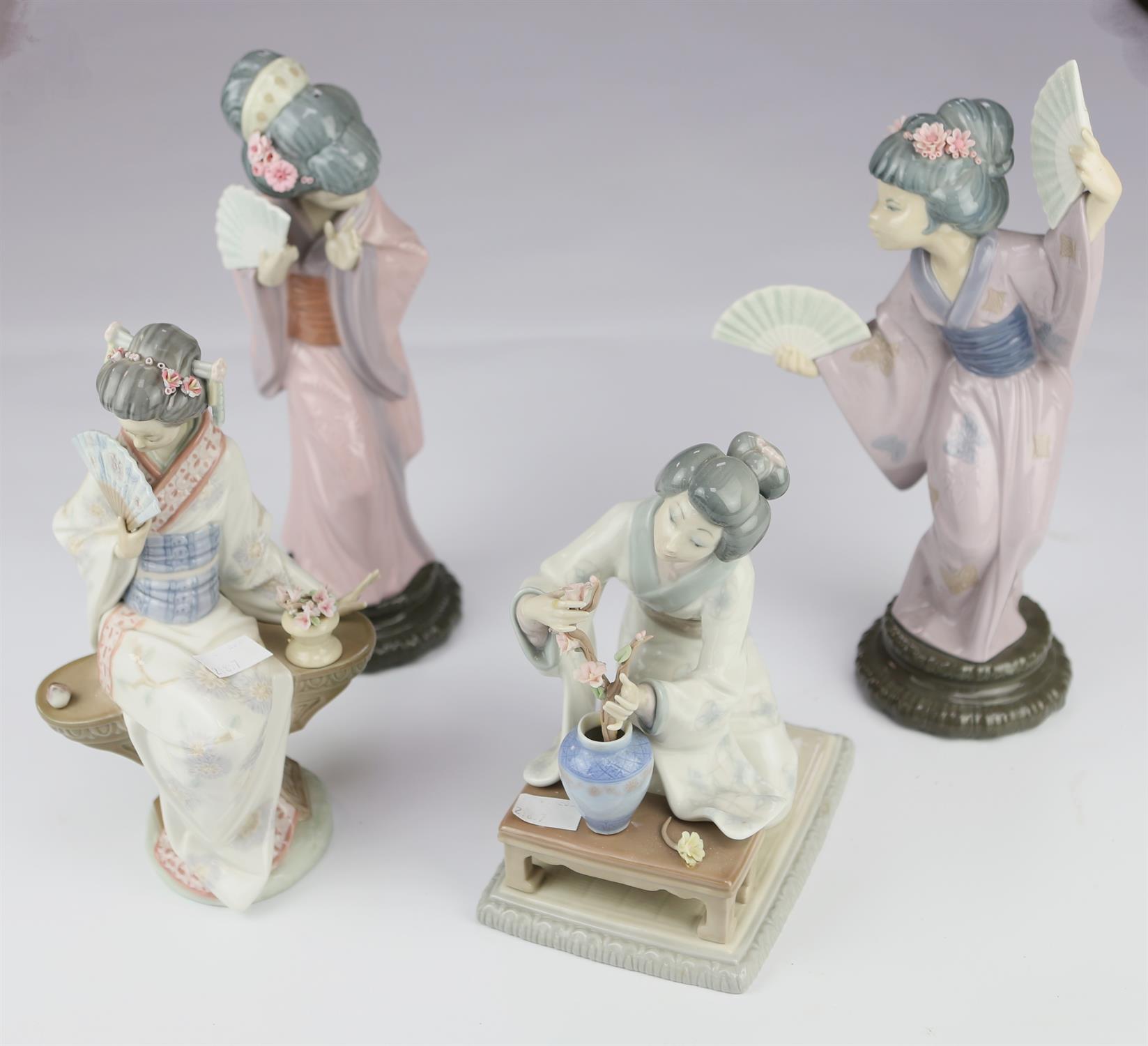 Lladro, two Geisha ladies, with fans, on stepped socles, together with ...
