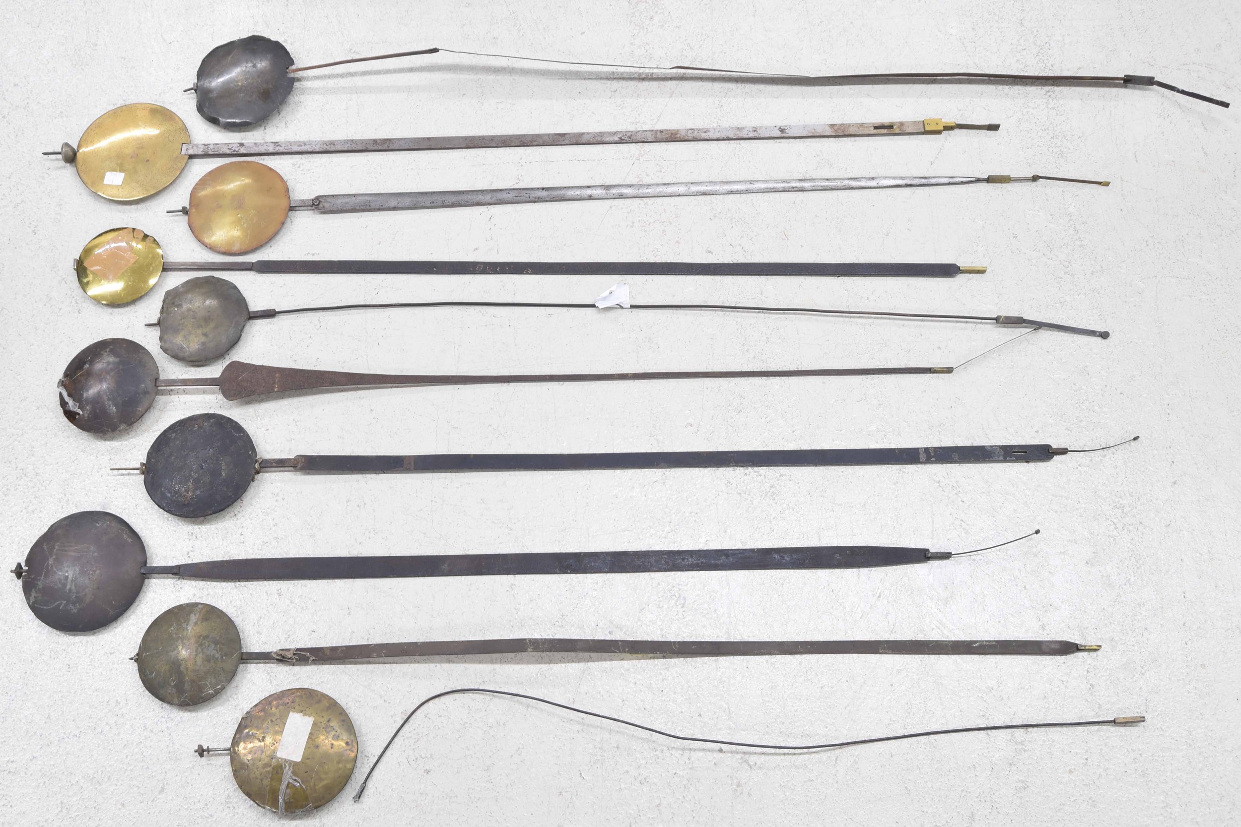 Ten various longcase clock pendulums with iron rods and brass bobs (10)