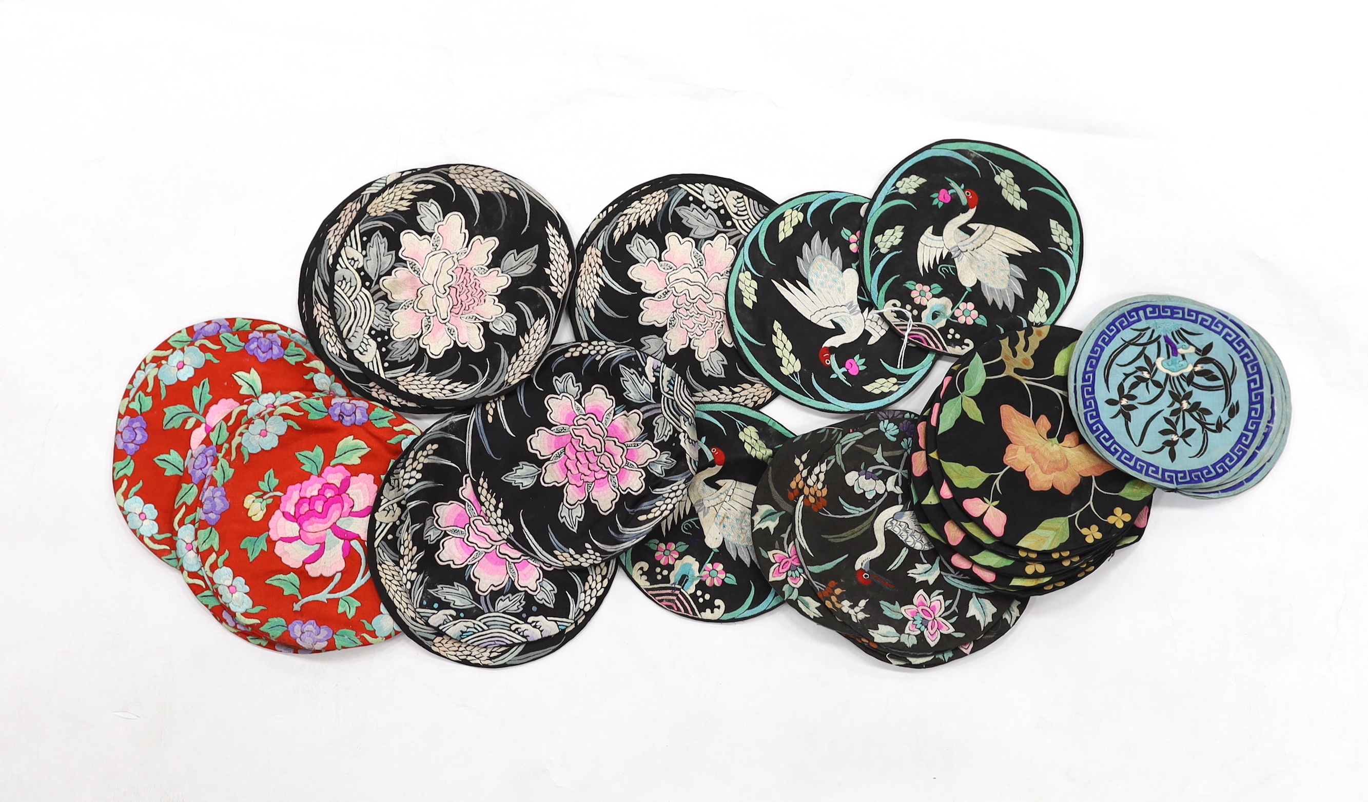 Four sets of eight circular Chinese silk embroidered mats and a set of ...