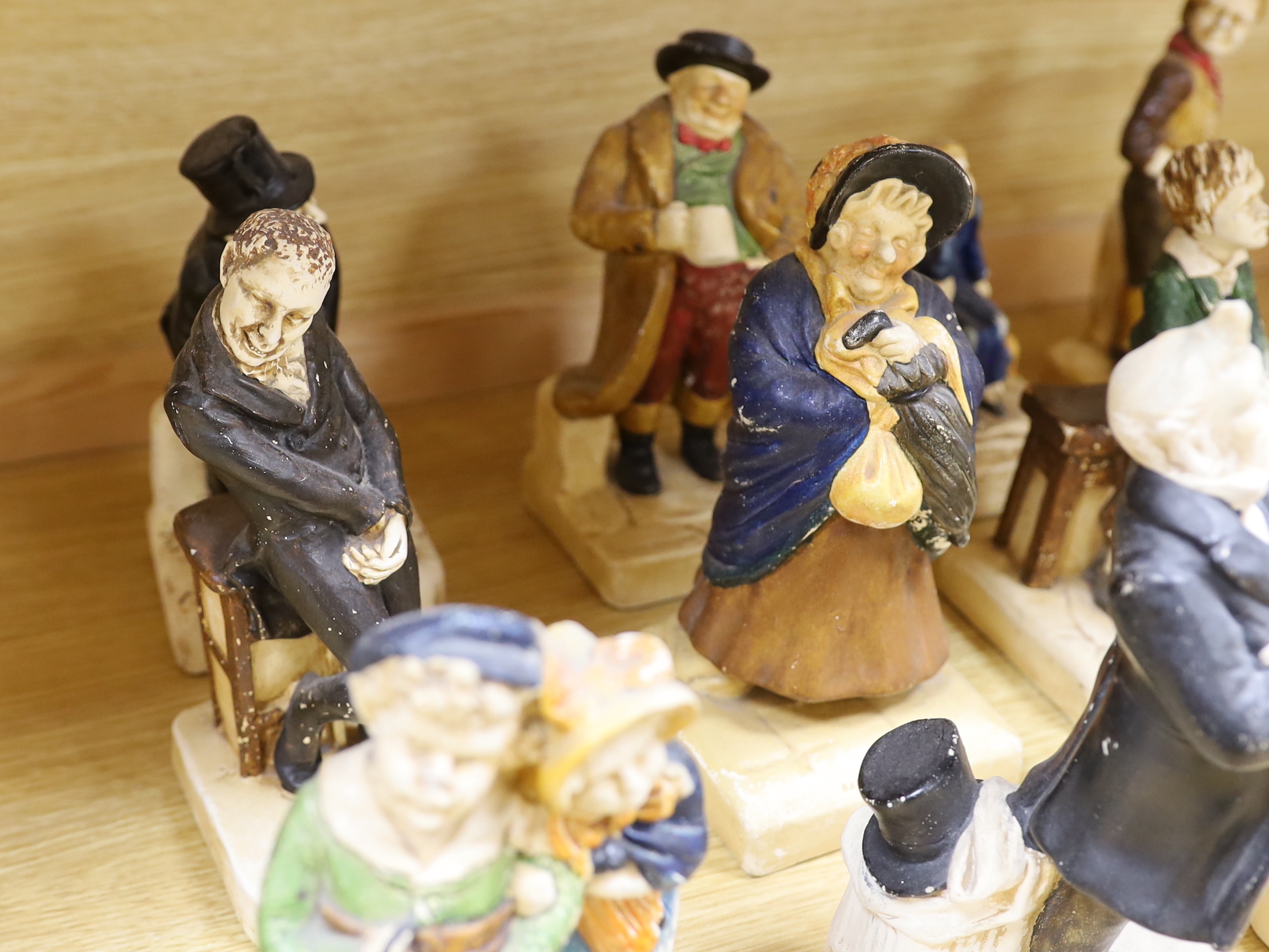 A collection of twelve Bretby cold painted pottery Dickens character ...