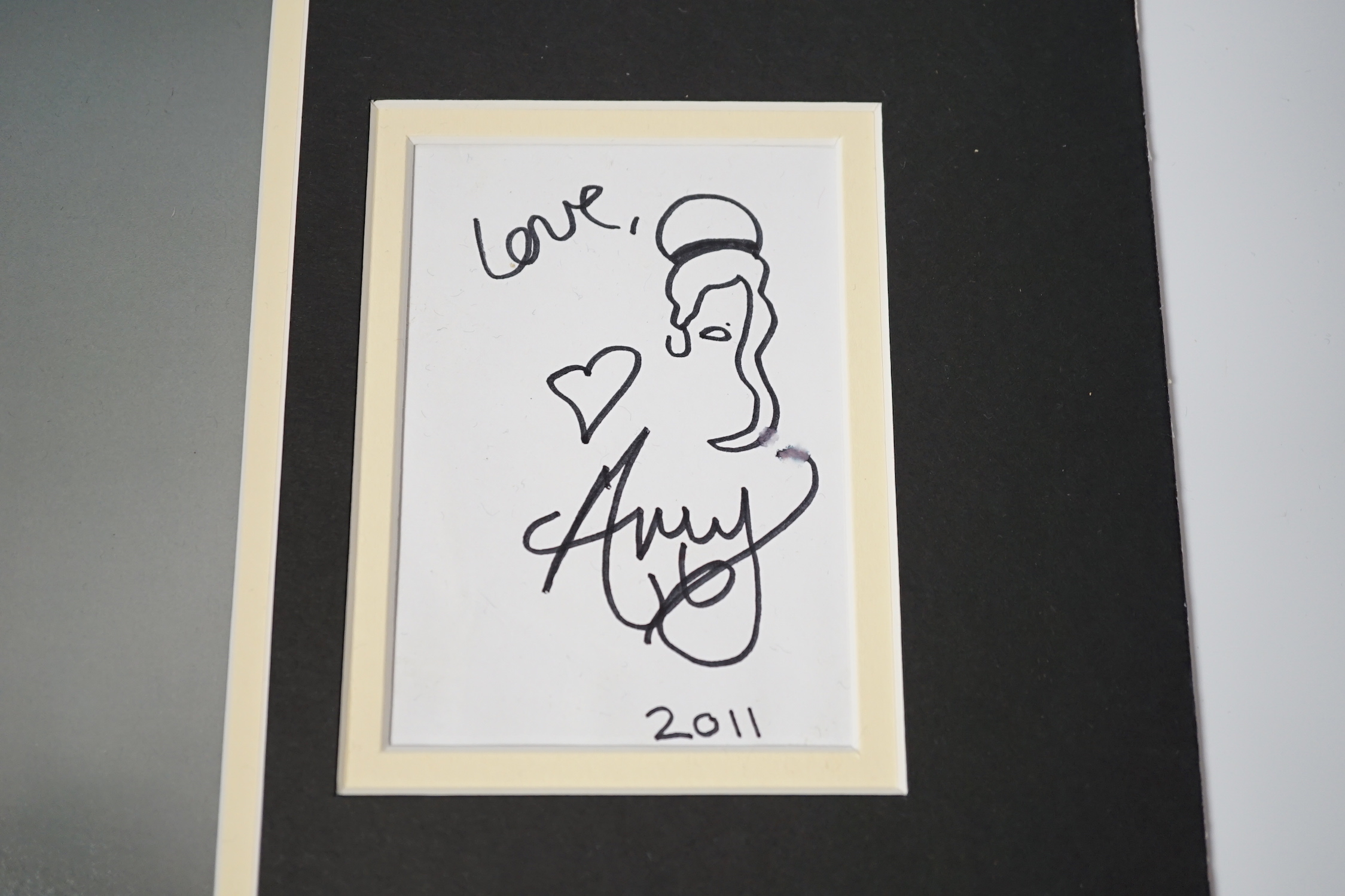 Amy Winehouse, an autograph with caricature self portrait dated 2011 ...