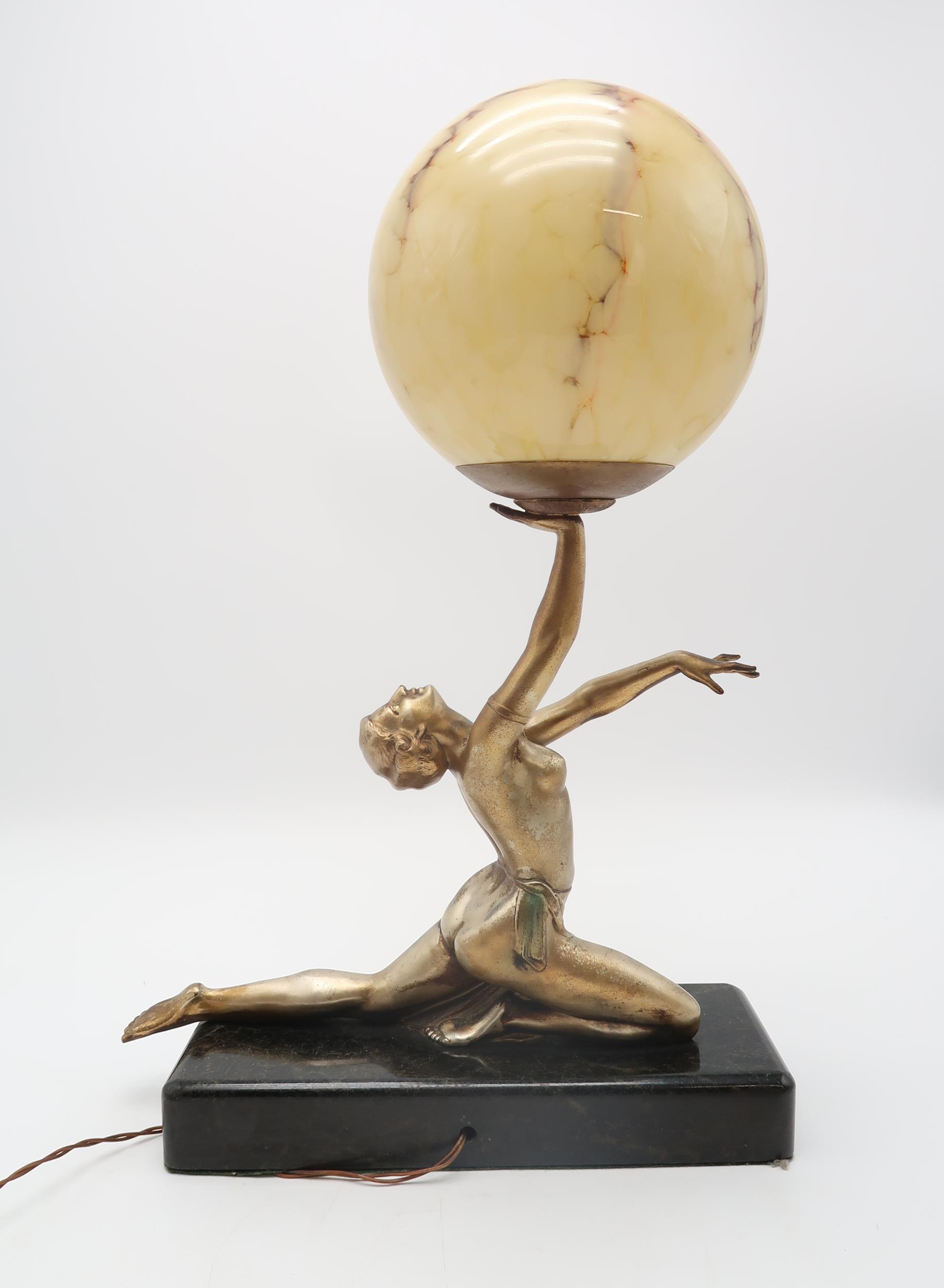 AN ART DECO GILDED METAL LADY LAMP modelled kneeling with arms ...
