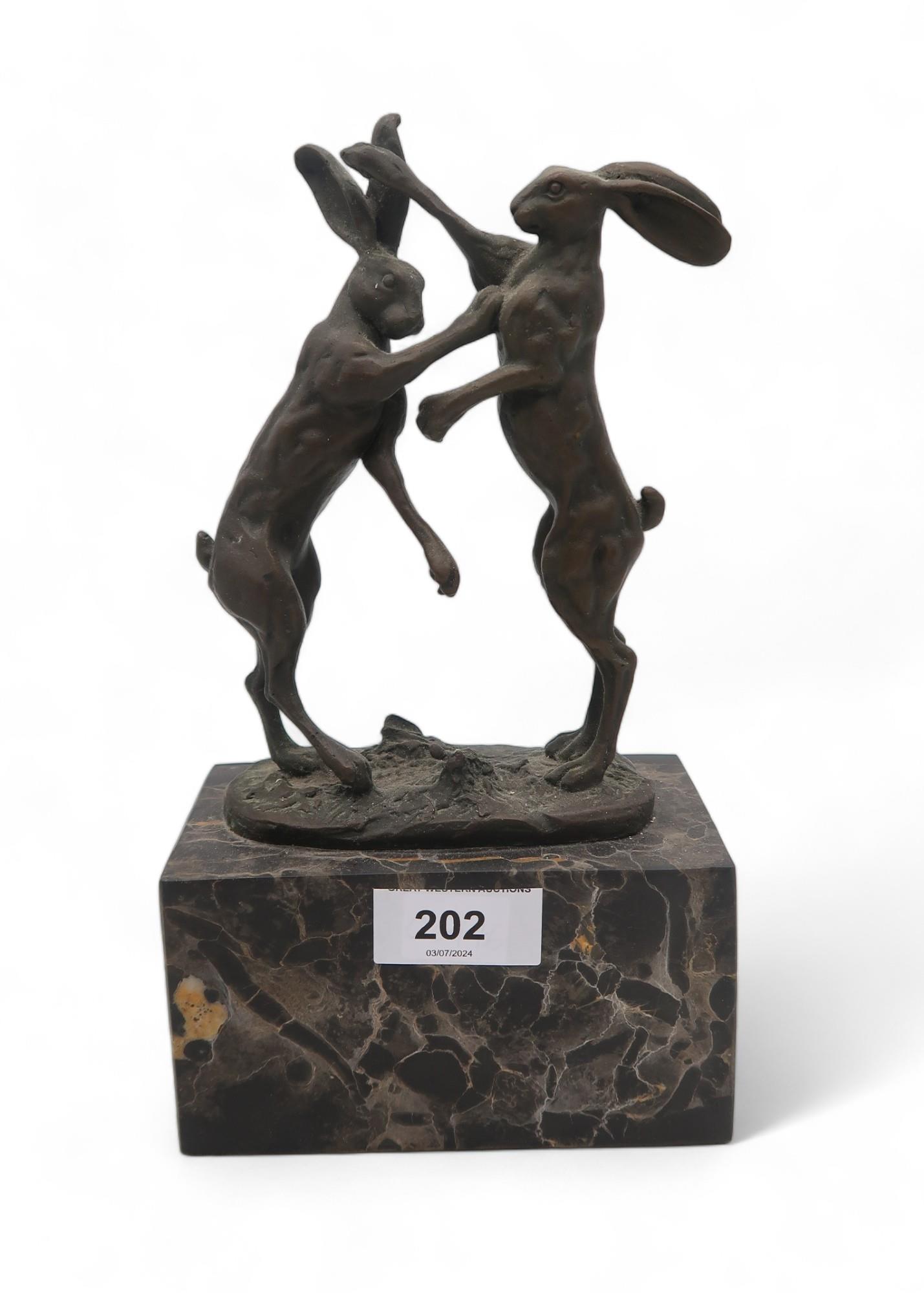 A bronze of boxing hares on marble base, signed Nick to the reverse ...