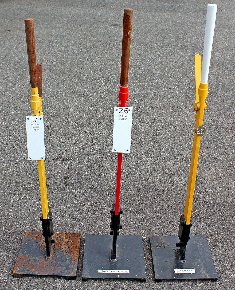 A trio of full length Signal Box Levers two of which have base ...