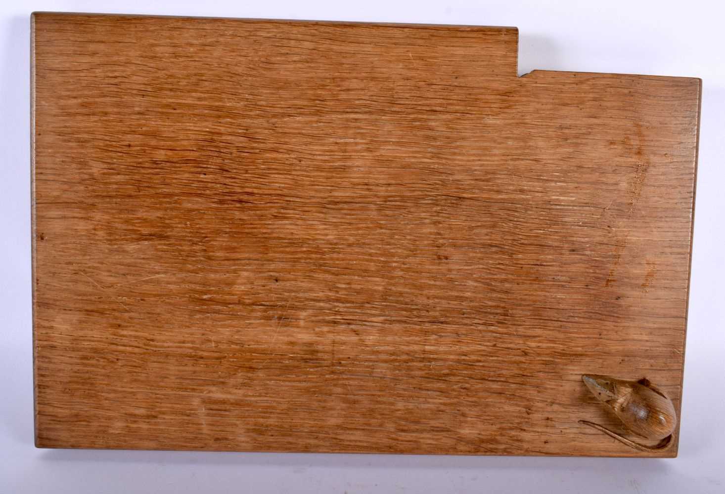 A ROBERT THOMPSON MOUSEMAN STYLE CHOPPING BOARD. 32 cm x 22 cm.
