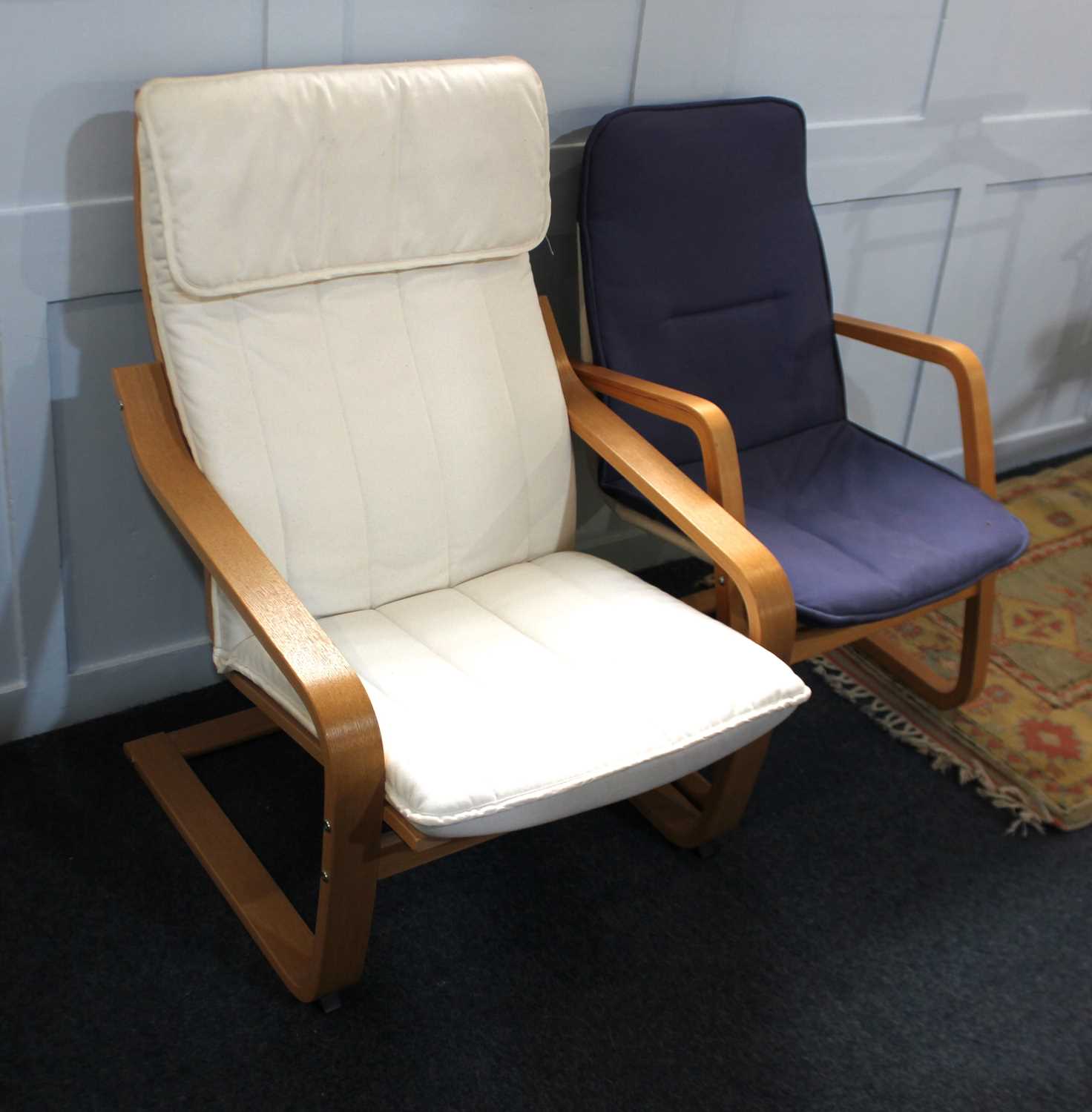 An IKEA 'Poang' armchair with white cushion cover and a child's 'Poang ...