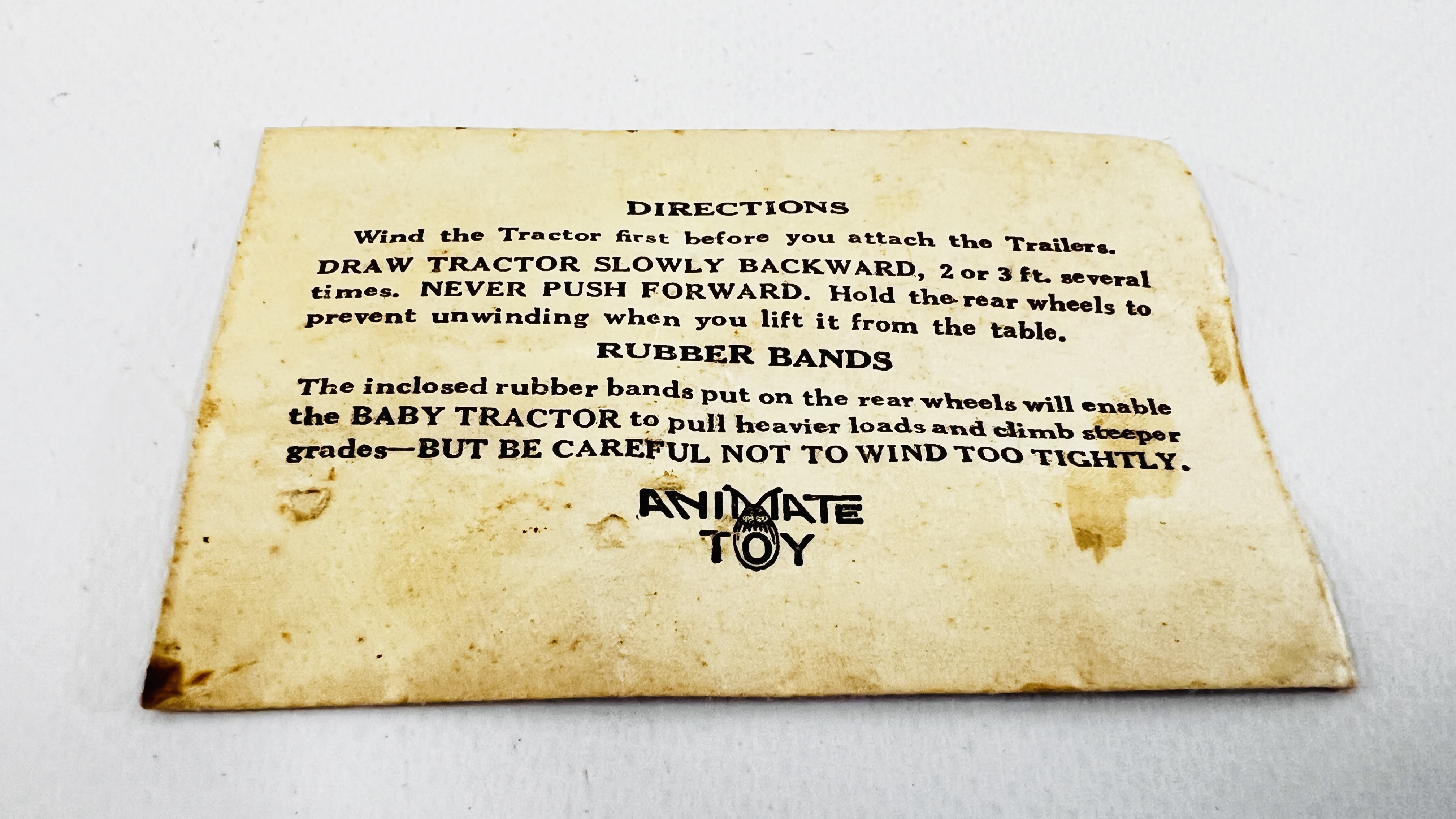 A VINTAGE ANIMATE TOY, TIN PLATE, BABY TRACTOR & TRAILERS IN ORIGINAL BOX.