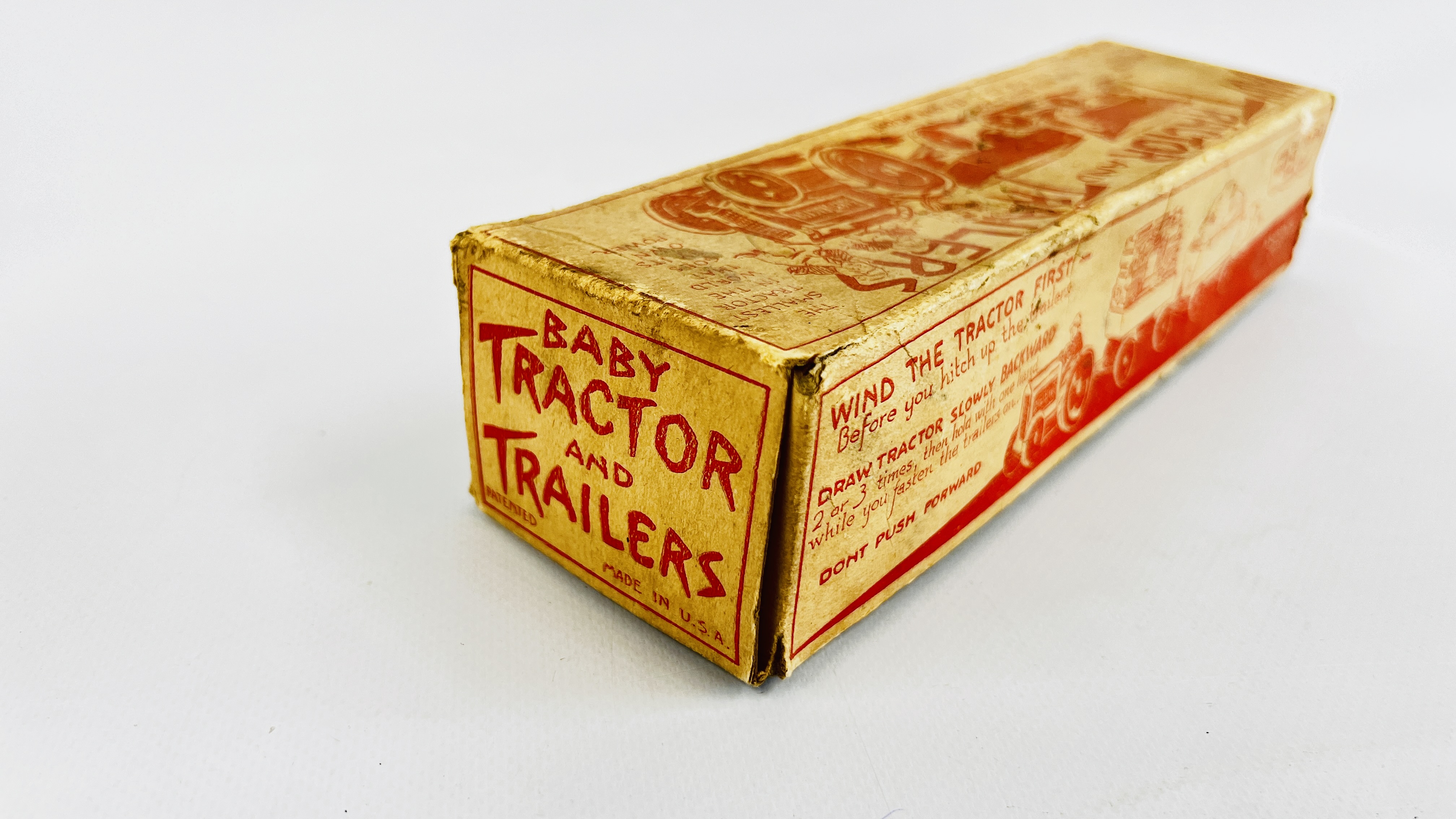 A VINTAGE ANIMATE TOY, TIN PLATE, BABY TRACTOR & TRAILERS IN ORIGINAL BOX.