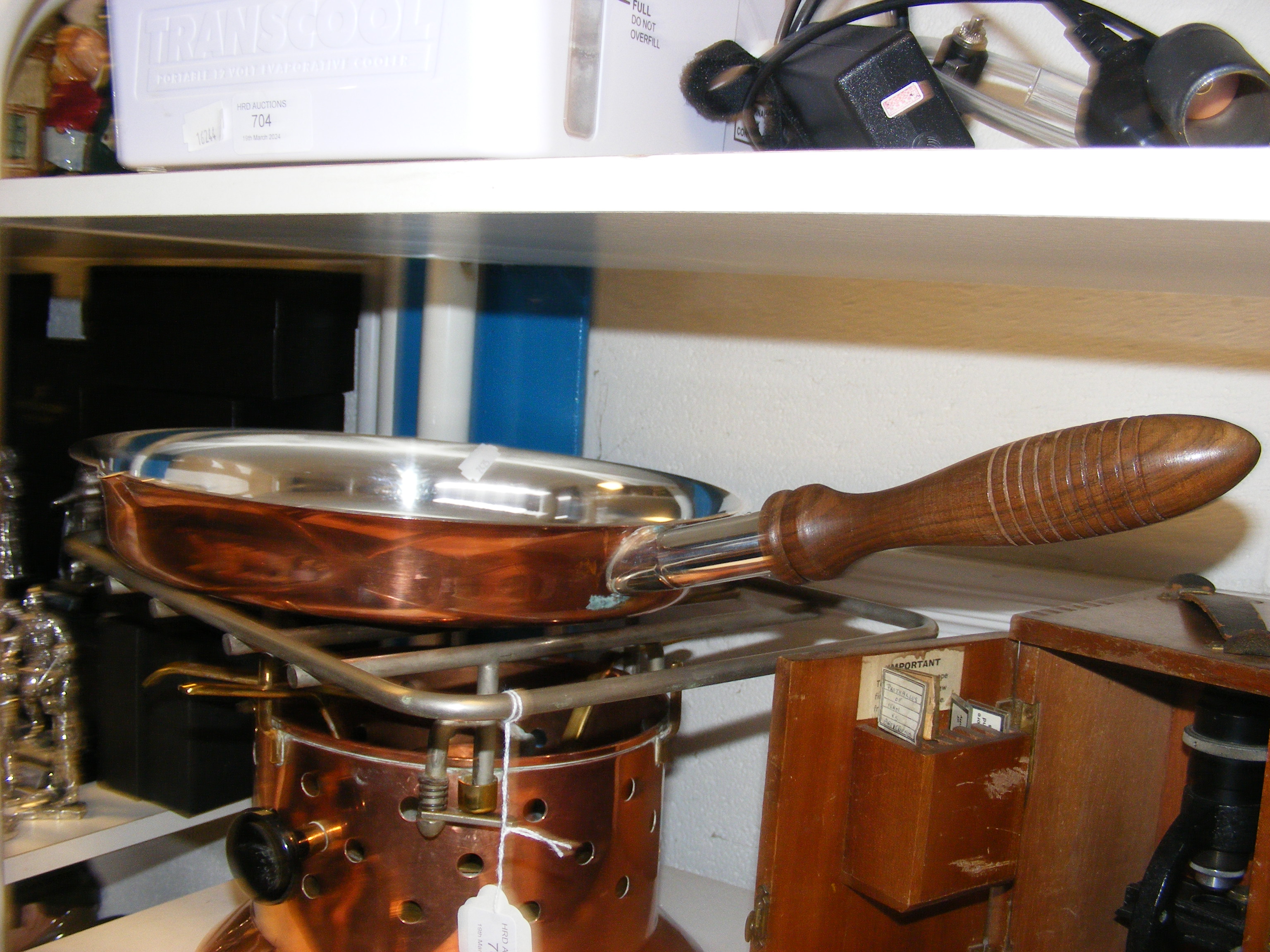 A vintage copper and brass tabletop burner with flambe grill and two pans