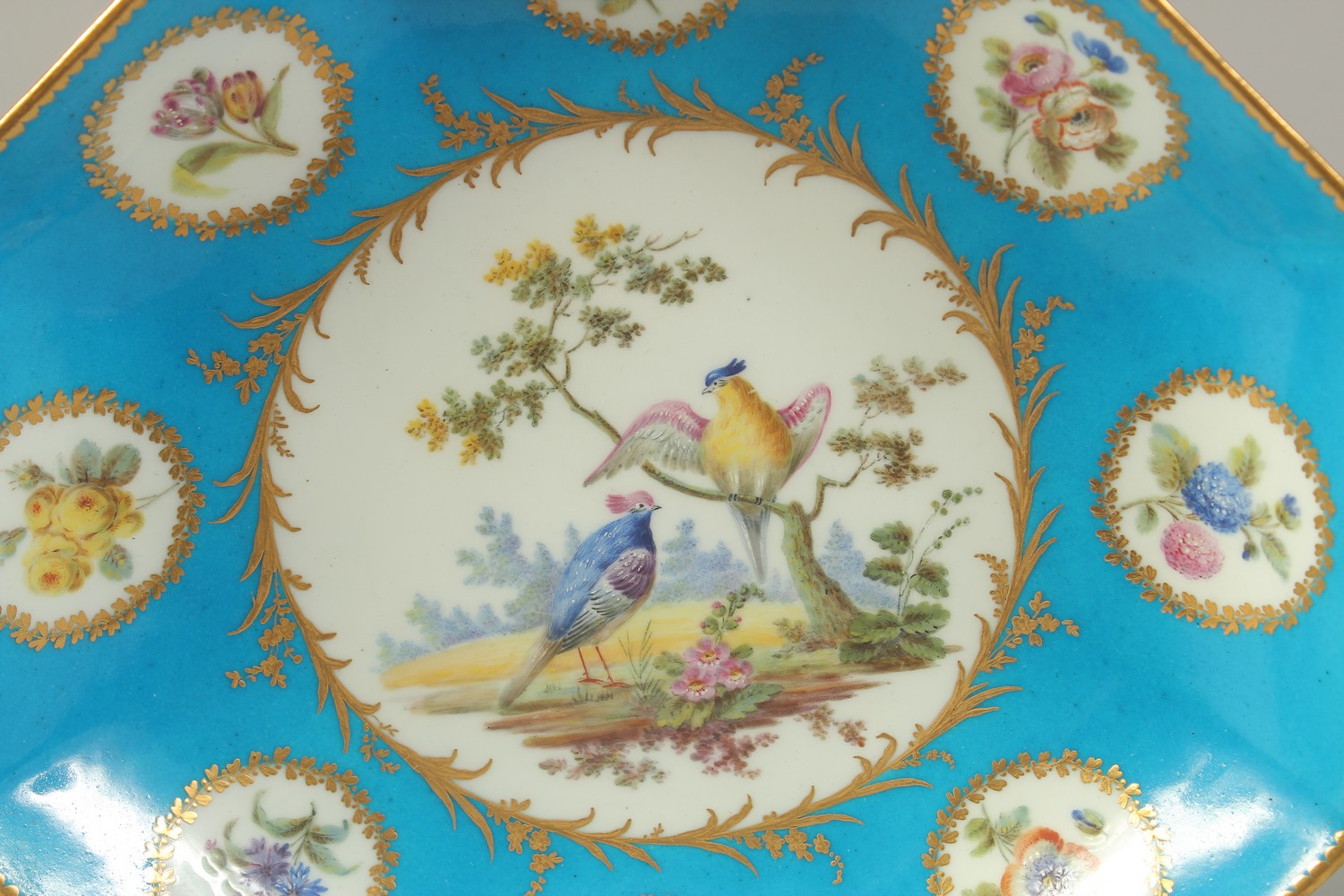 AN 18TH CENTURY SEVRES OCTAGONAL DISH, painted with birds in a ...