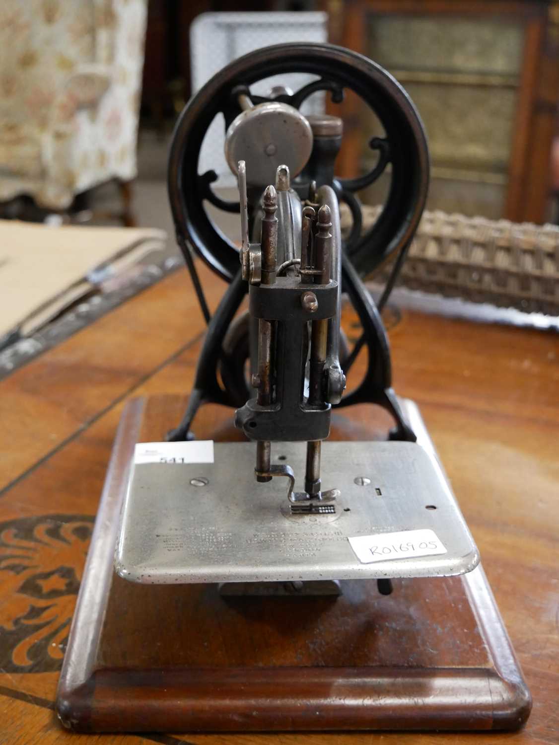 Wilcox & Gibbs sewing machine, raised on a hardwood base
