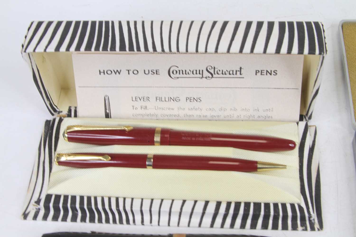 A Conway Stewart 106 lady's fountain pen, having a red cap and barrel ...