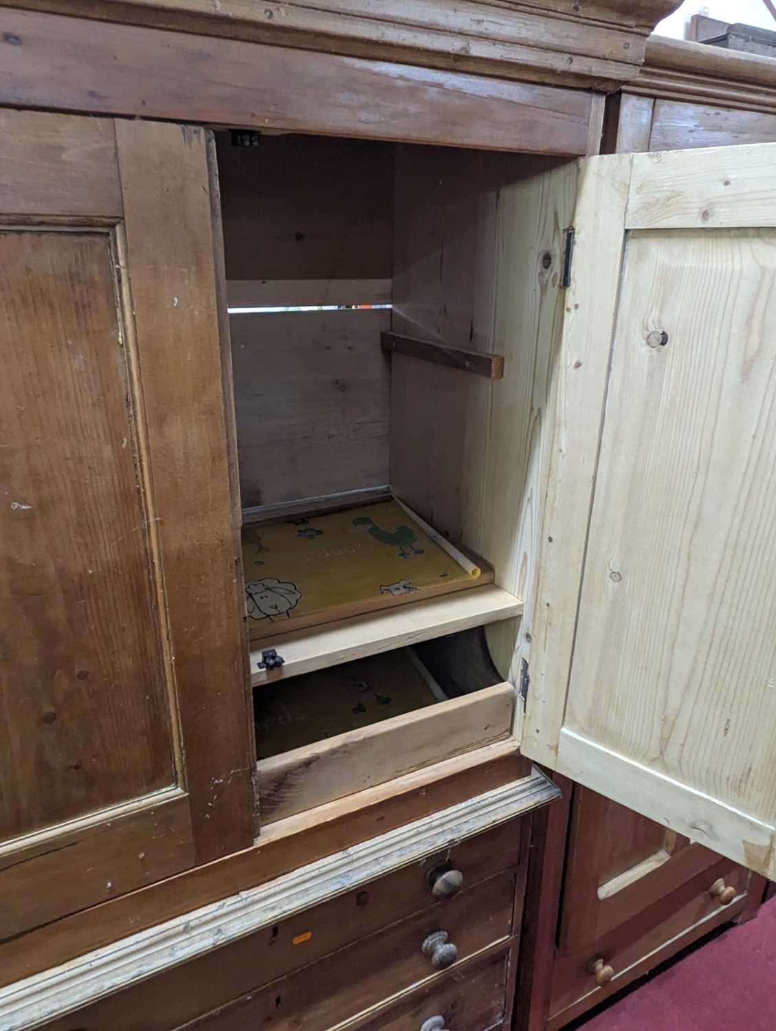 A rustic pine linen cupboard, the twin upper doors over base fitted ...
