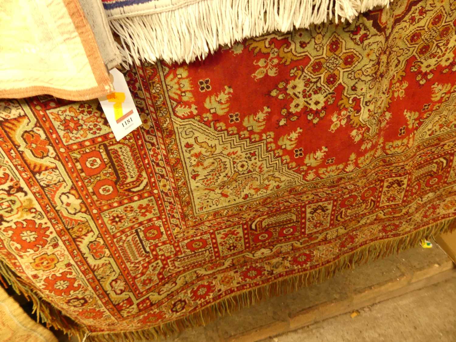 An Afghan red ground woollen table covering, having knotted and ...