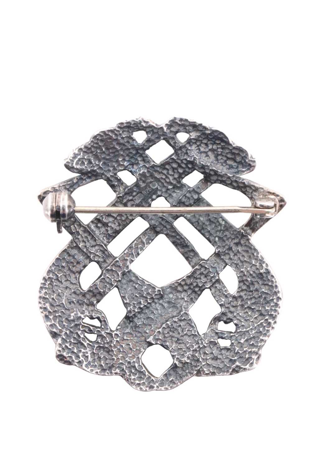 A silver Orkney brooch designed by Malcom Gray, having Celtic beasts ...