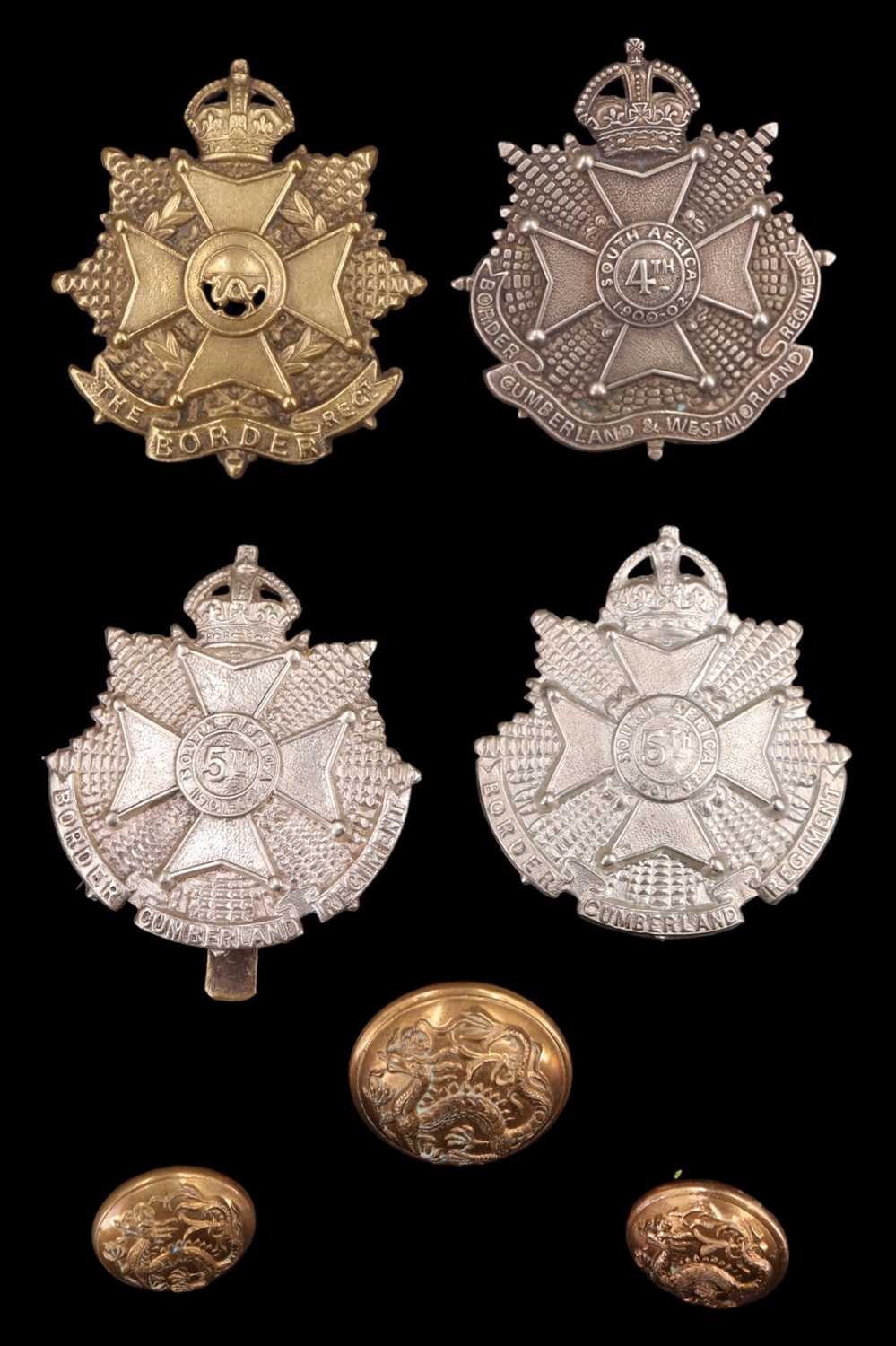 A group of Border Regiment cap badges and buttons