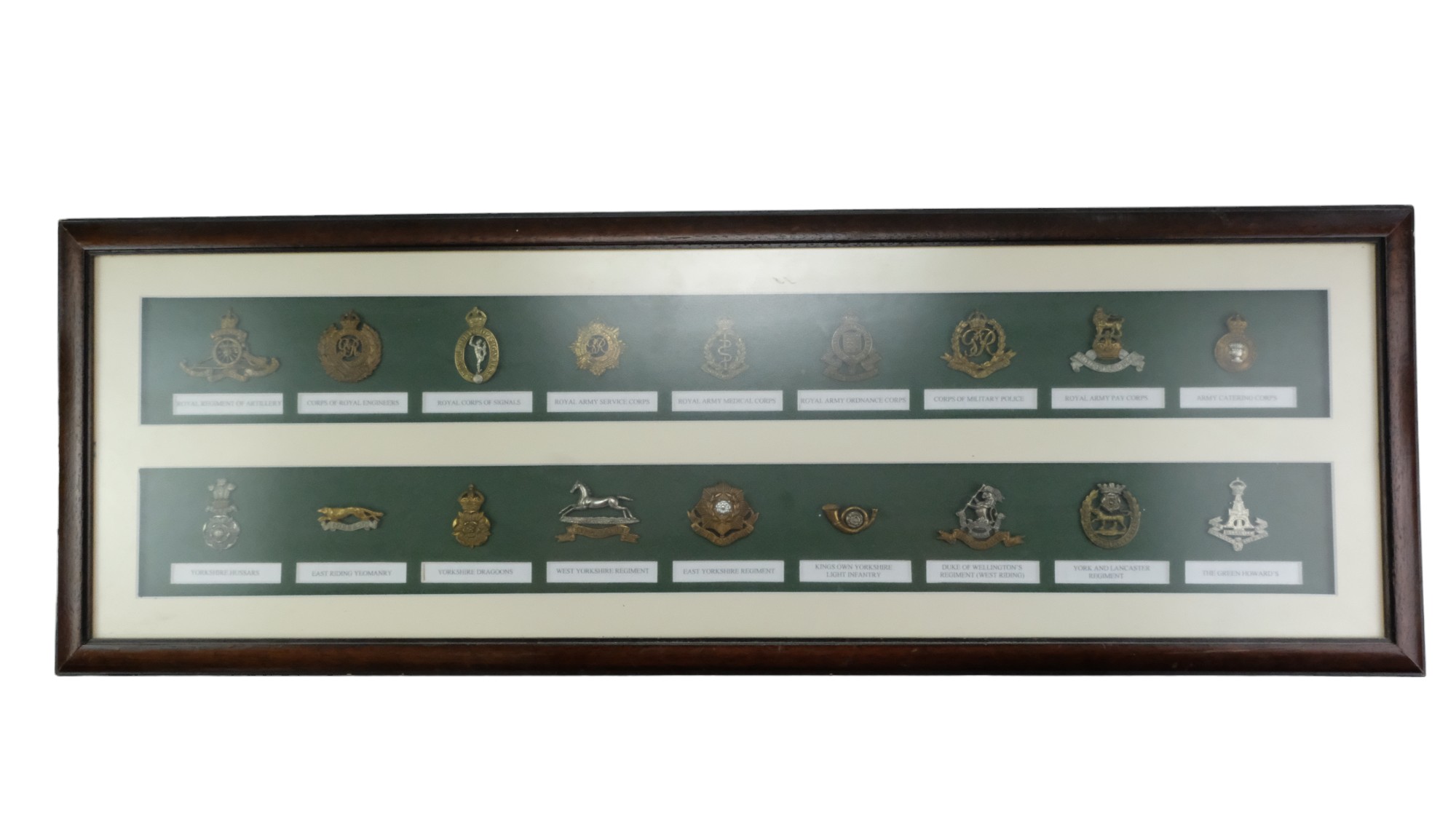 A framed display of British army cap badges