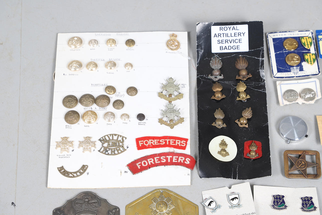 A mixed collection of badges, buttons and similar items to include ...