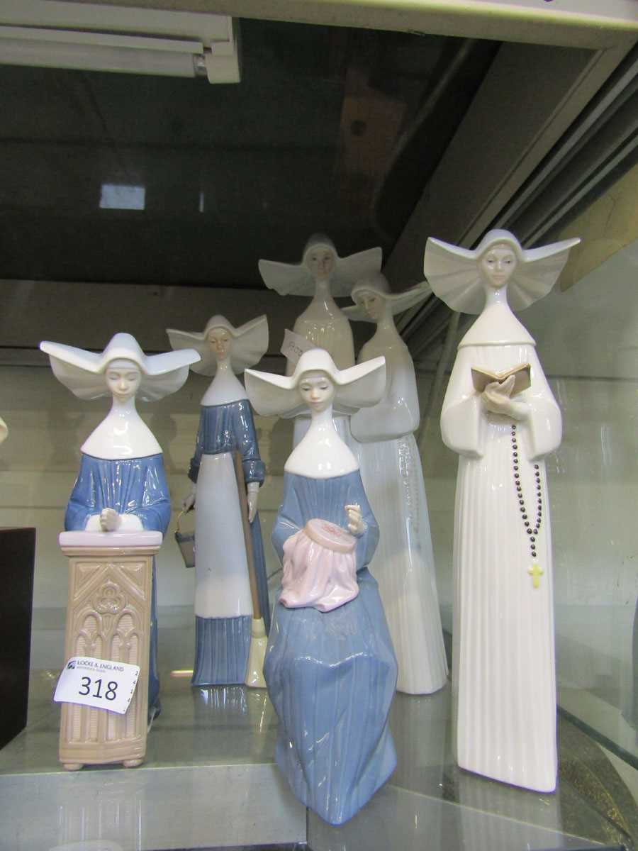 Four Lladro ceramic figurines of nuns along with a Lladro ceramic ...
