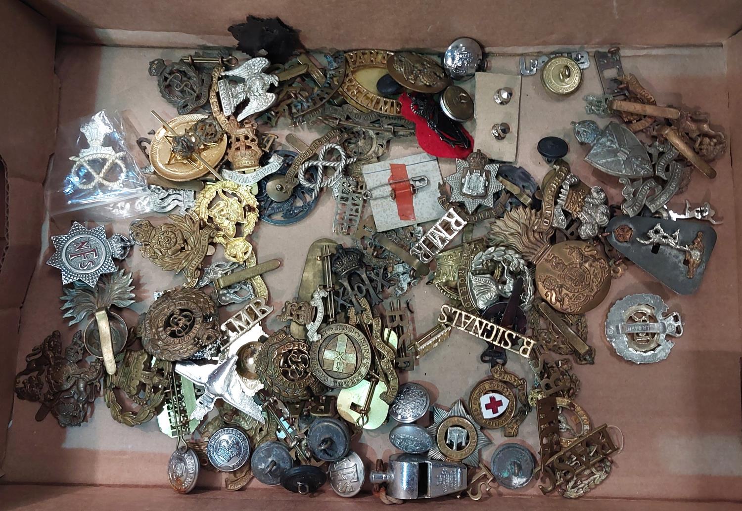 A collection of various military badges and buttons etc