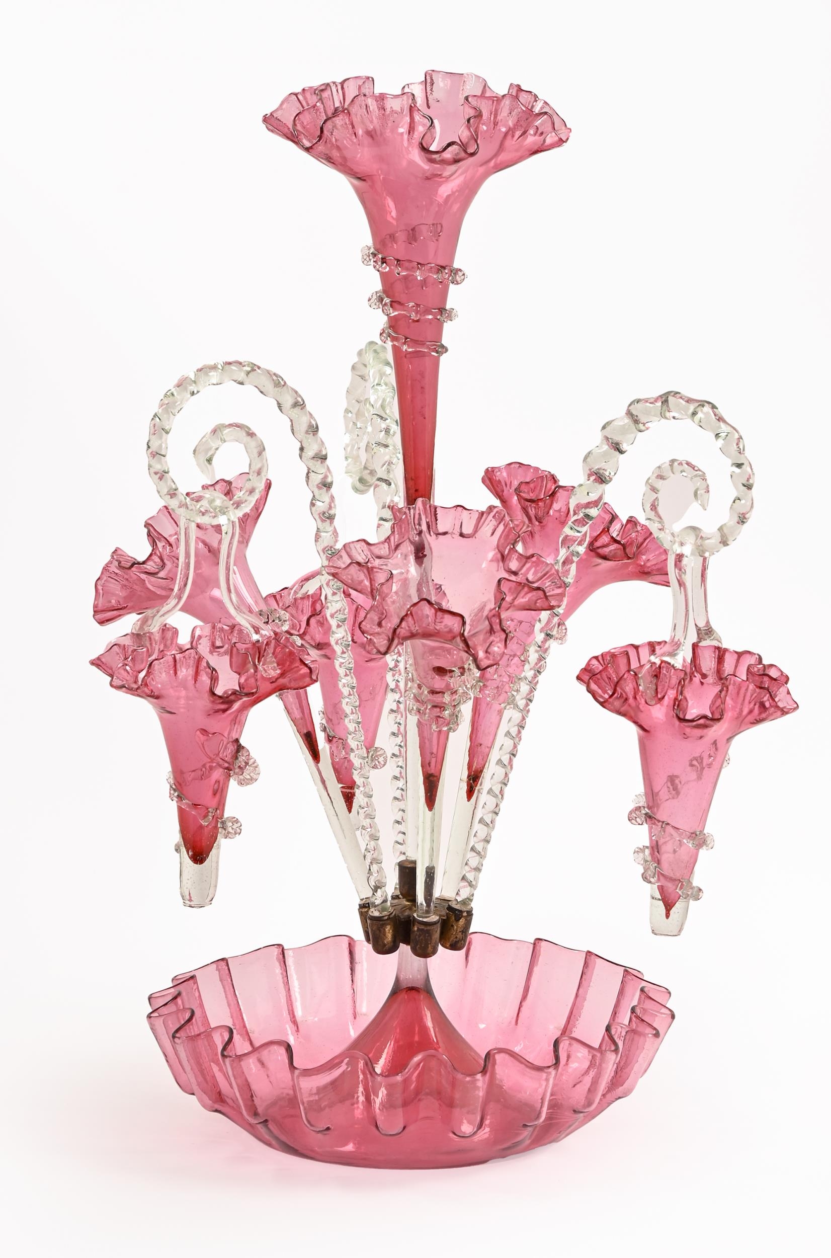 A Victorian cranberry glass flower stand, of four vases and three ...