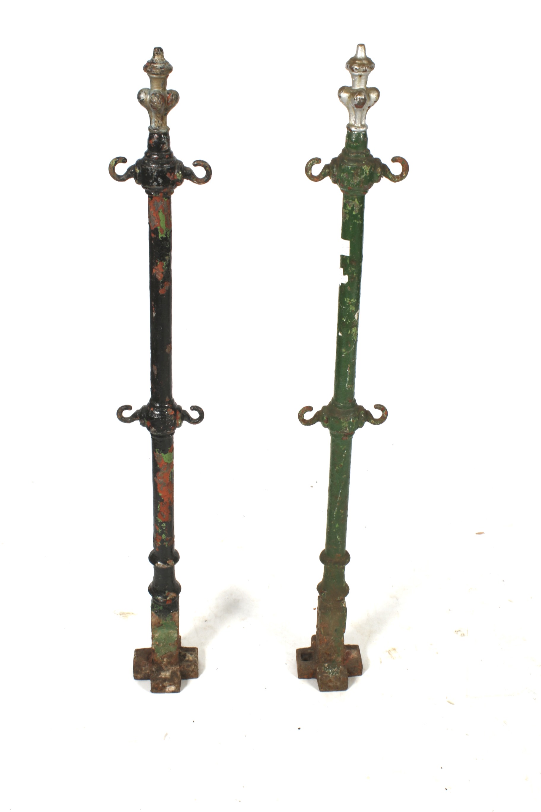 A pair of Victorian cast iron posts. One painted green, the other ...