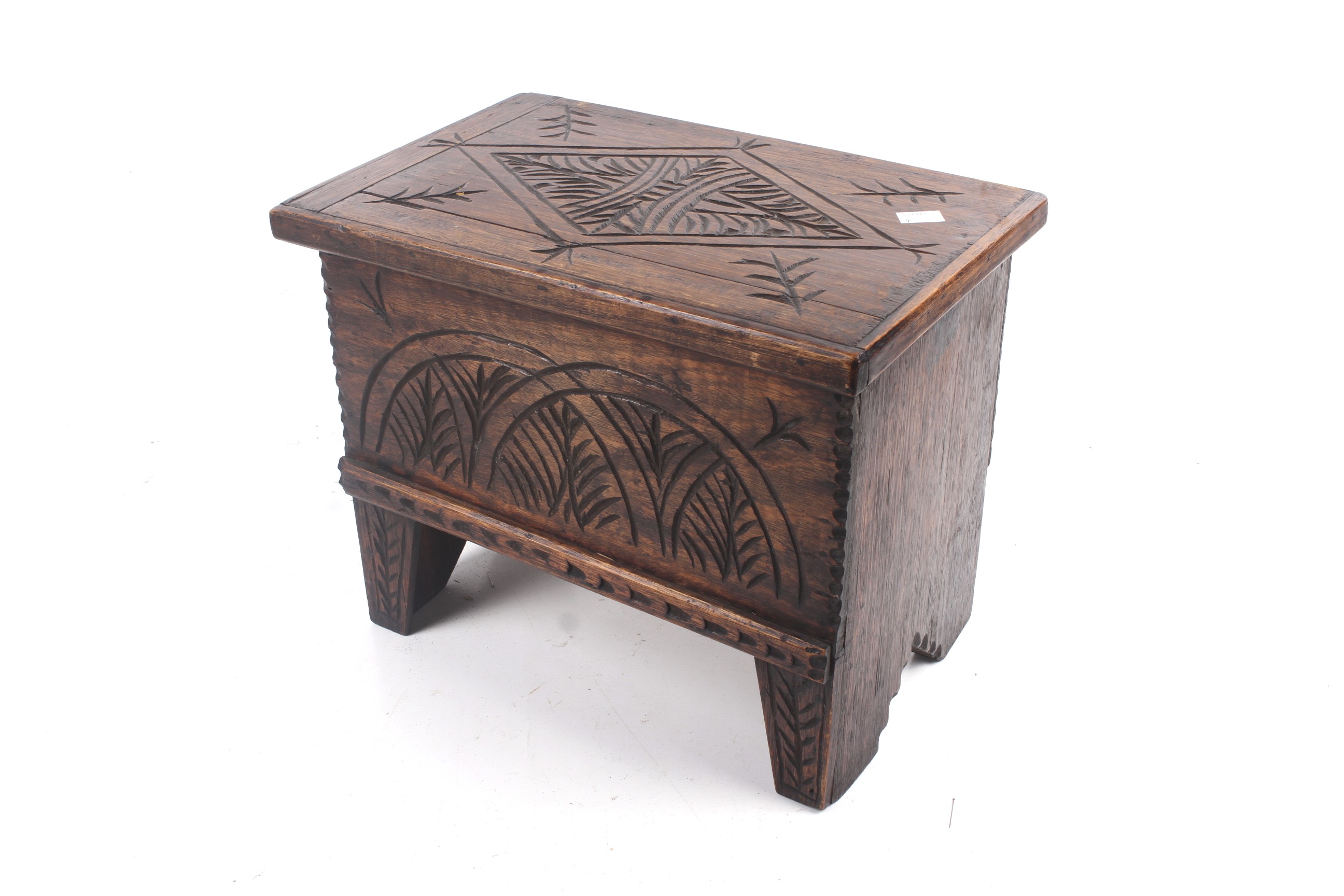 A 19th century oak slipper box. The hinged lid and sides with carved ...