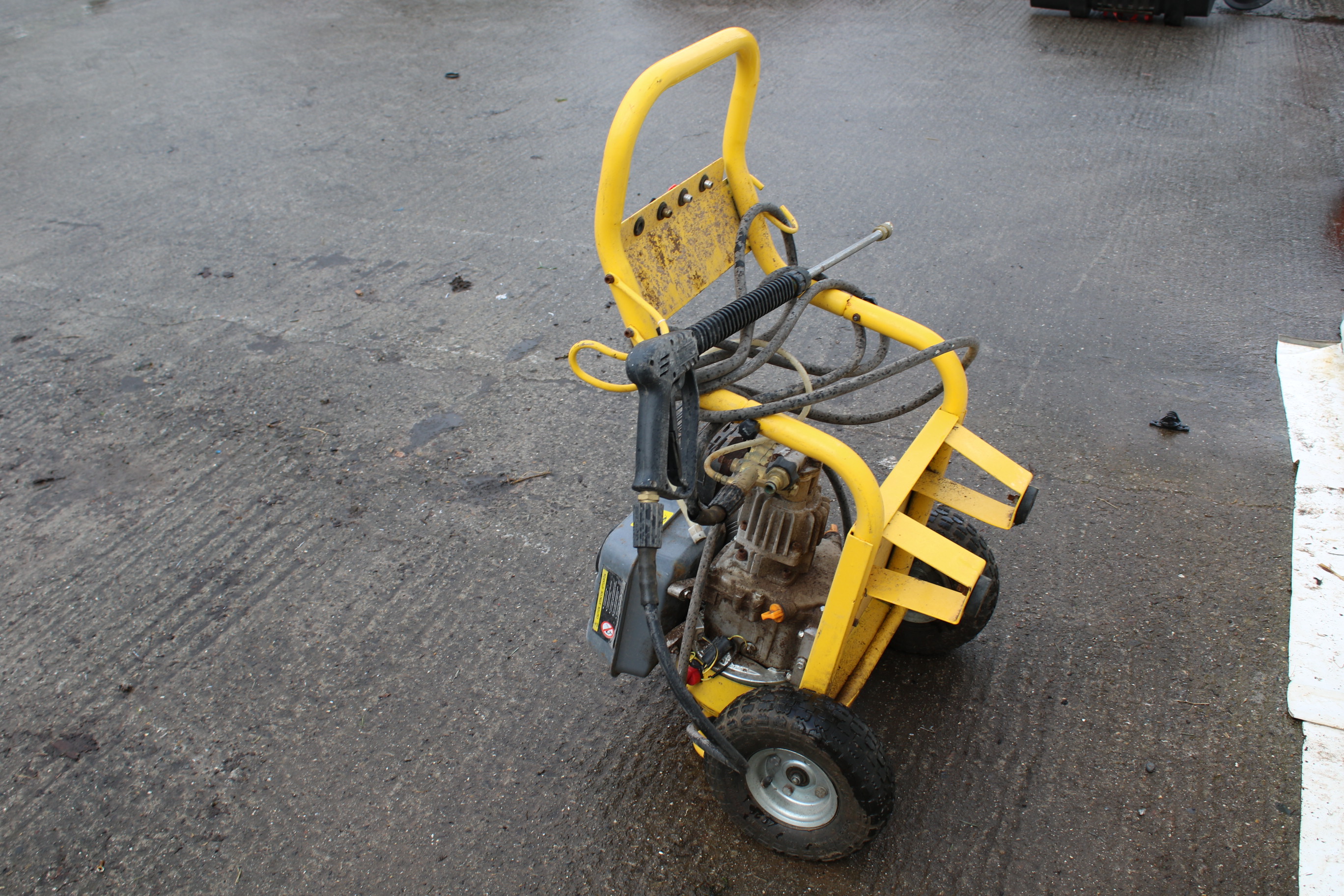 A Gardenpro power plus petrol pressure washer. In yellow, on wheels ...