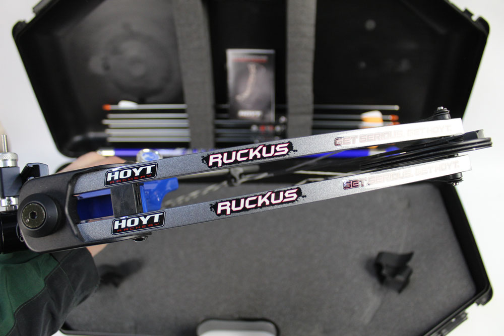 A Hoyt Ruckus compound bow, with stabilisation pole, arrows and hard case.