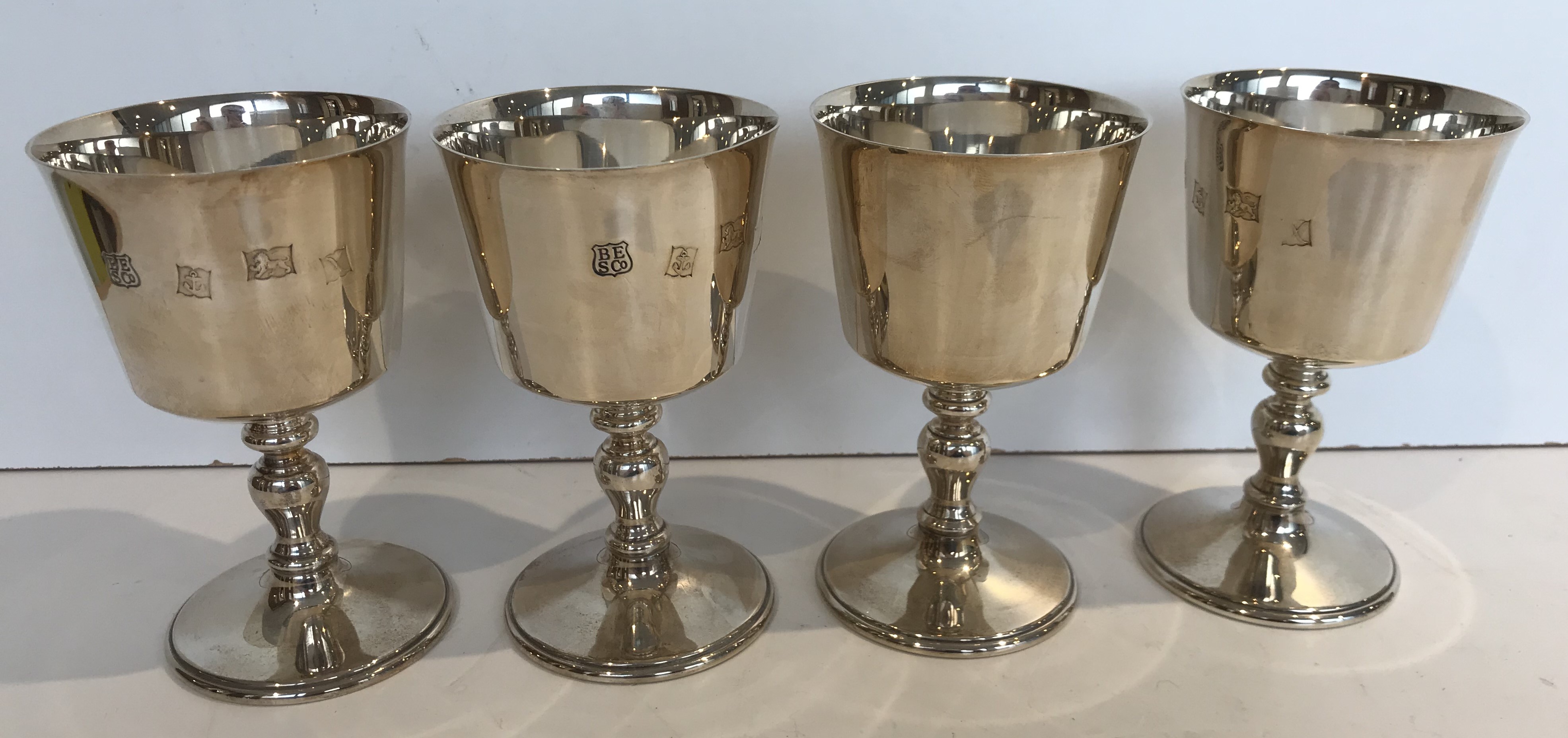 A set of four Queen Elizabeth II silver goblets, the bucket shape bowls ...