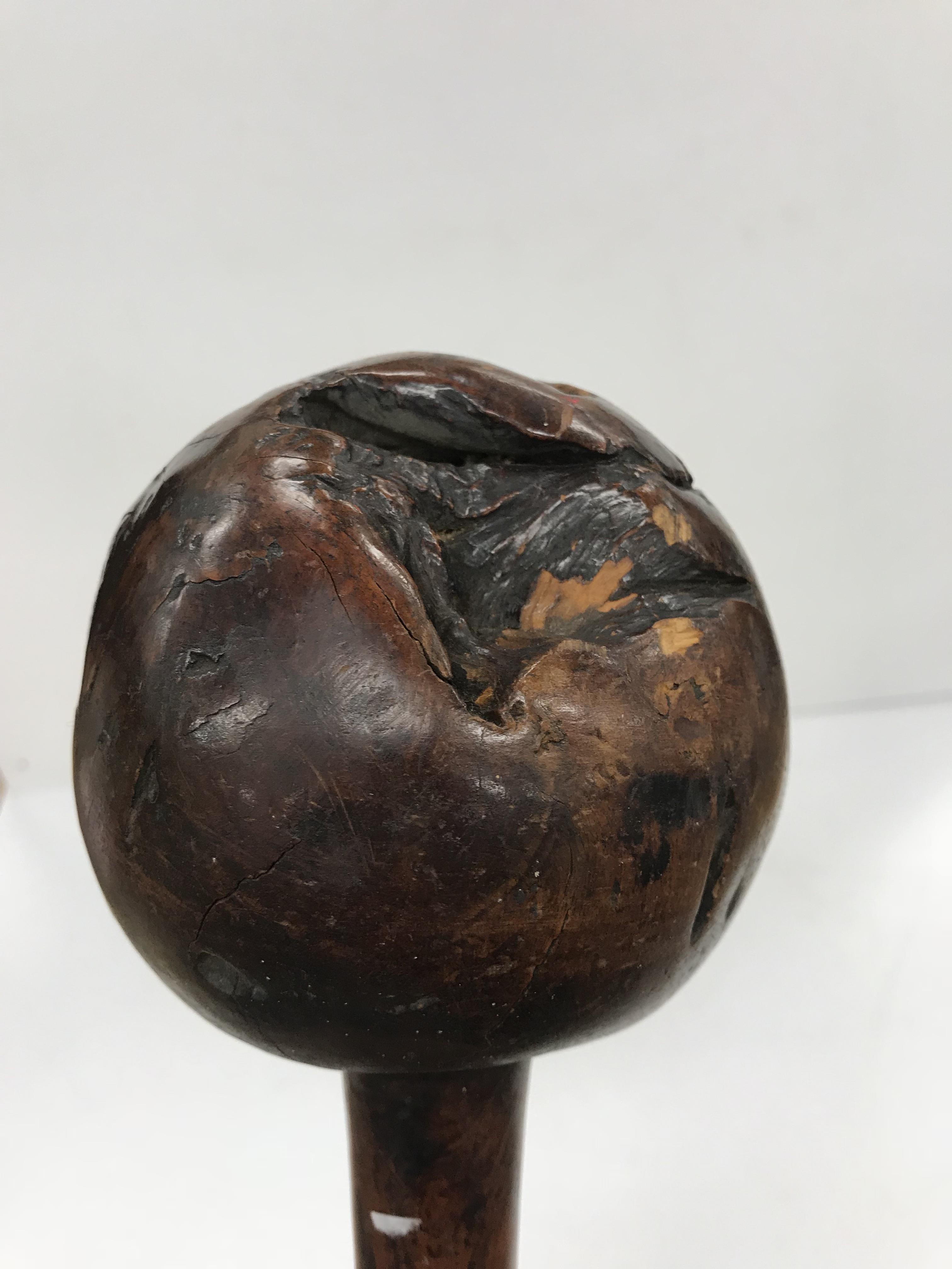 A 19th Century Zulu knobkerrie, the rough ball head on a turned handle ...