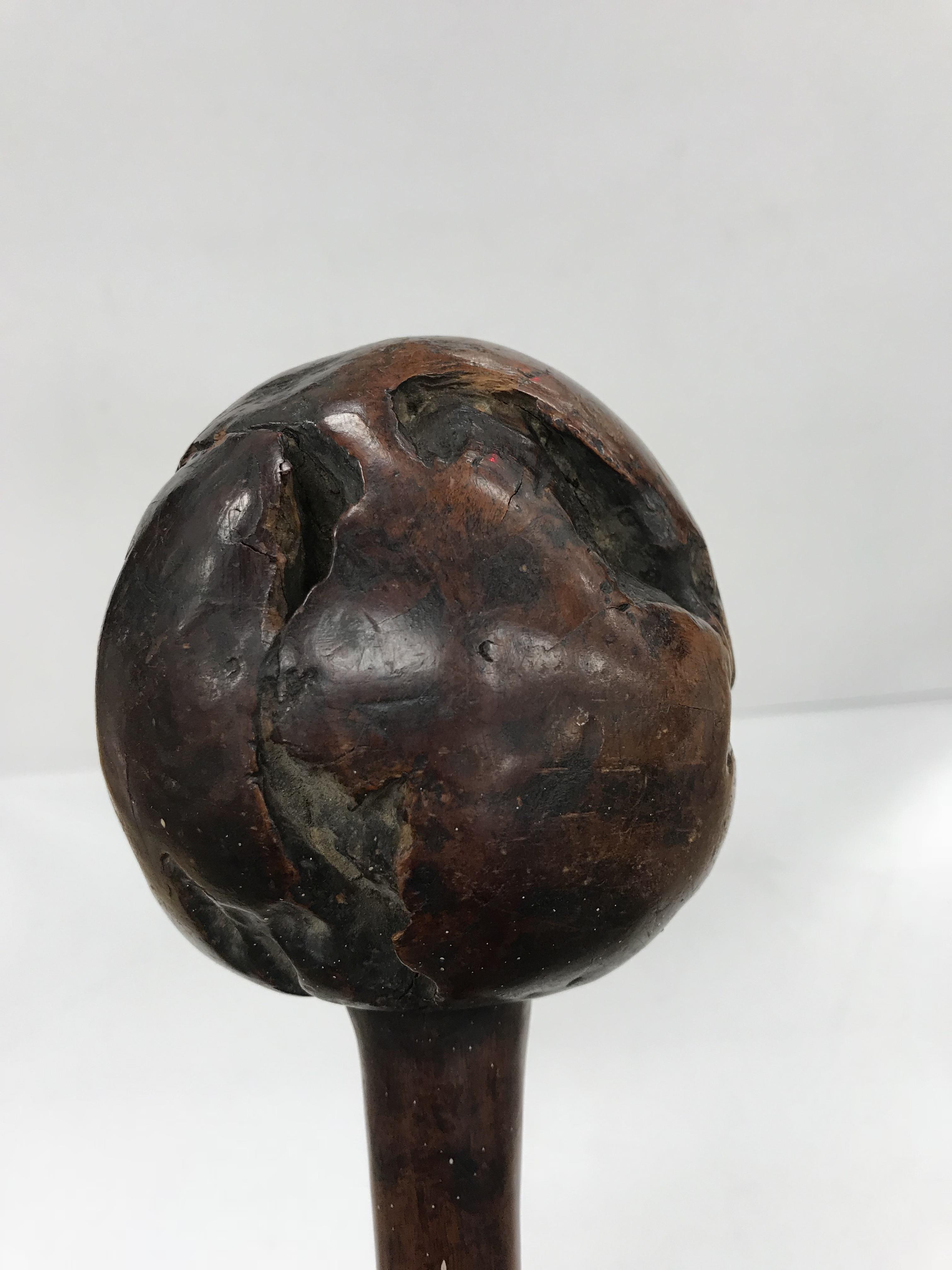A 19th Century Zulu knobkerrie, the rough ball head on a turned handle ...