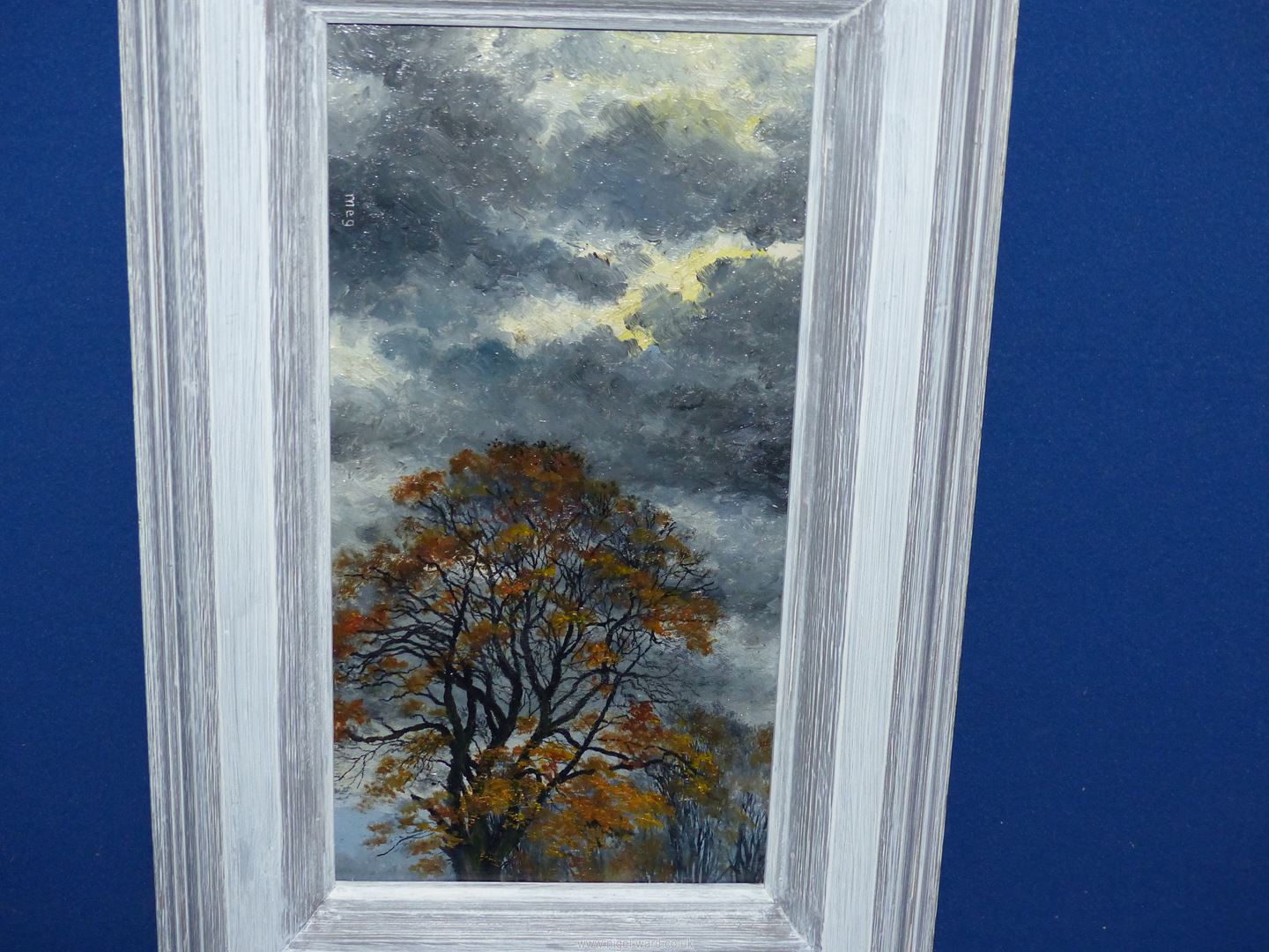 A framed Oil on board, signed verso Meg Stevens, depicting Trees on a ...
