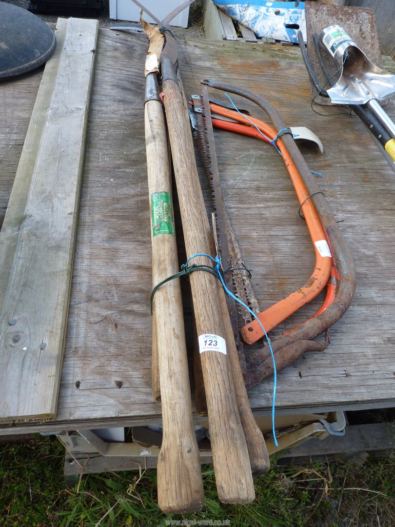 A quantity of hedge bills and three bow saws.