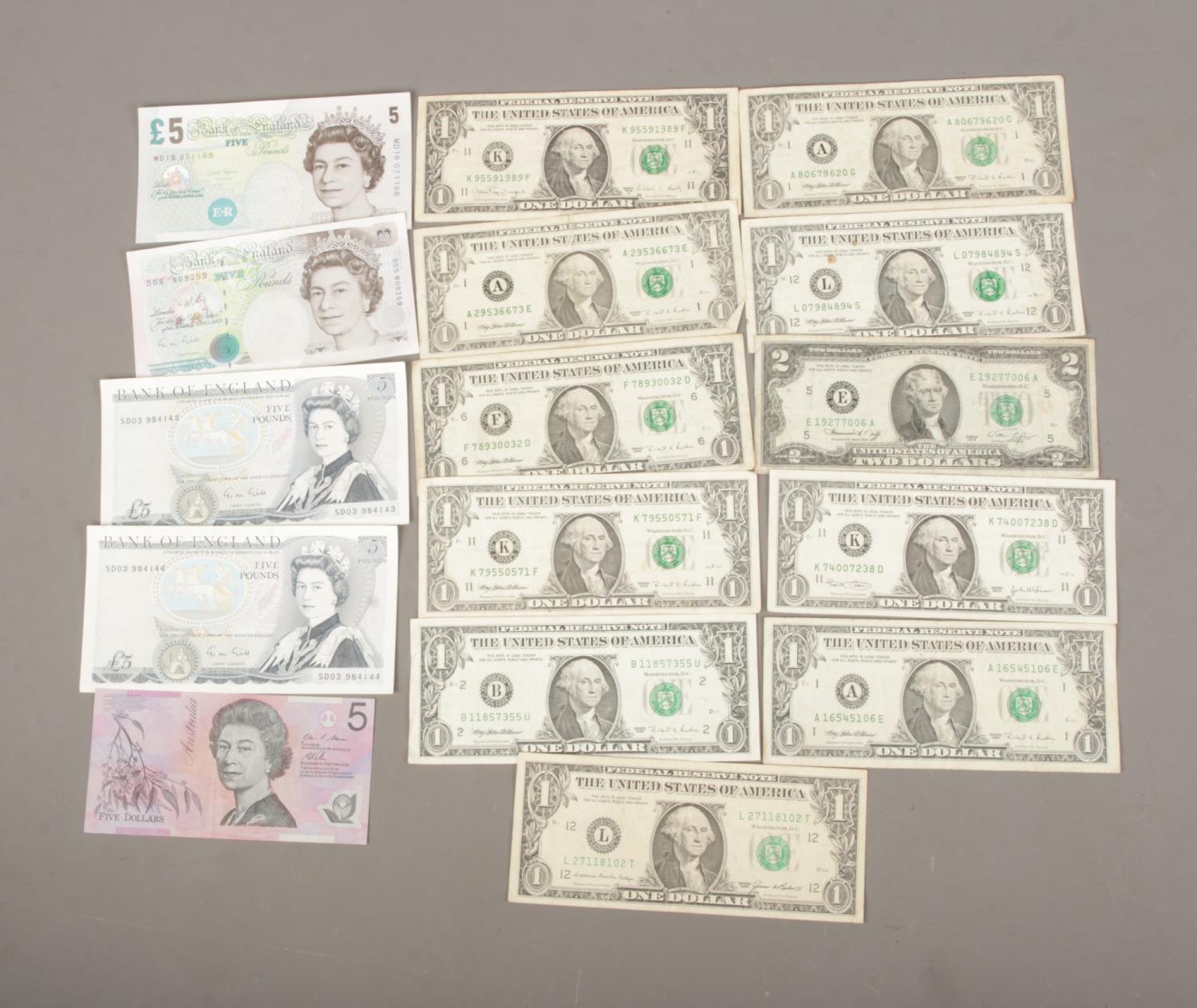 A collection of assorted world bank notes to include US dollar bills ...