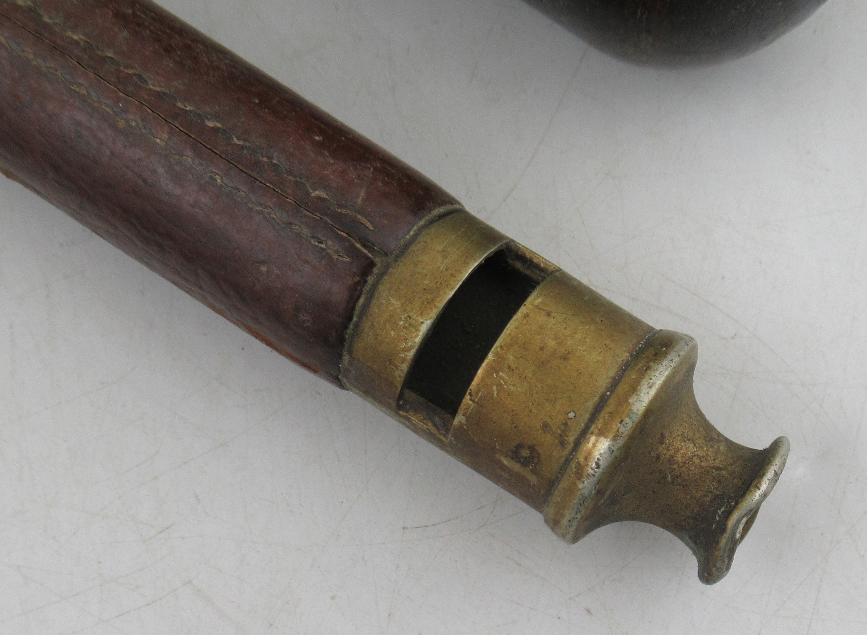 A turned wooden truncheon, together with a small carved stag dog ...