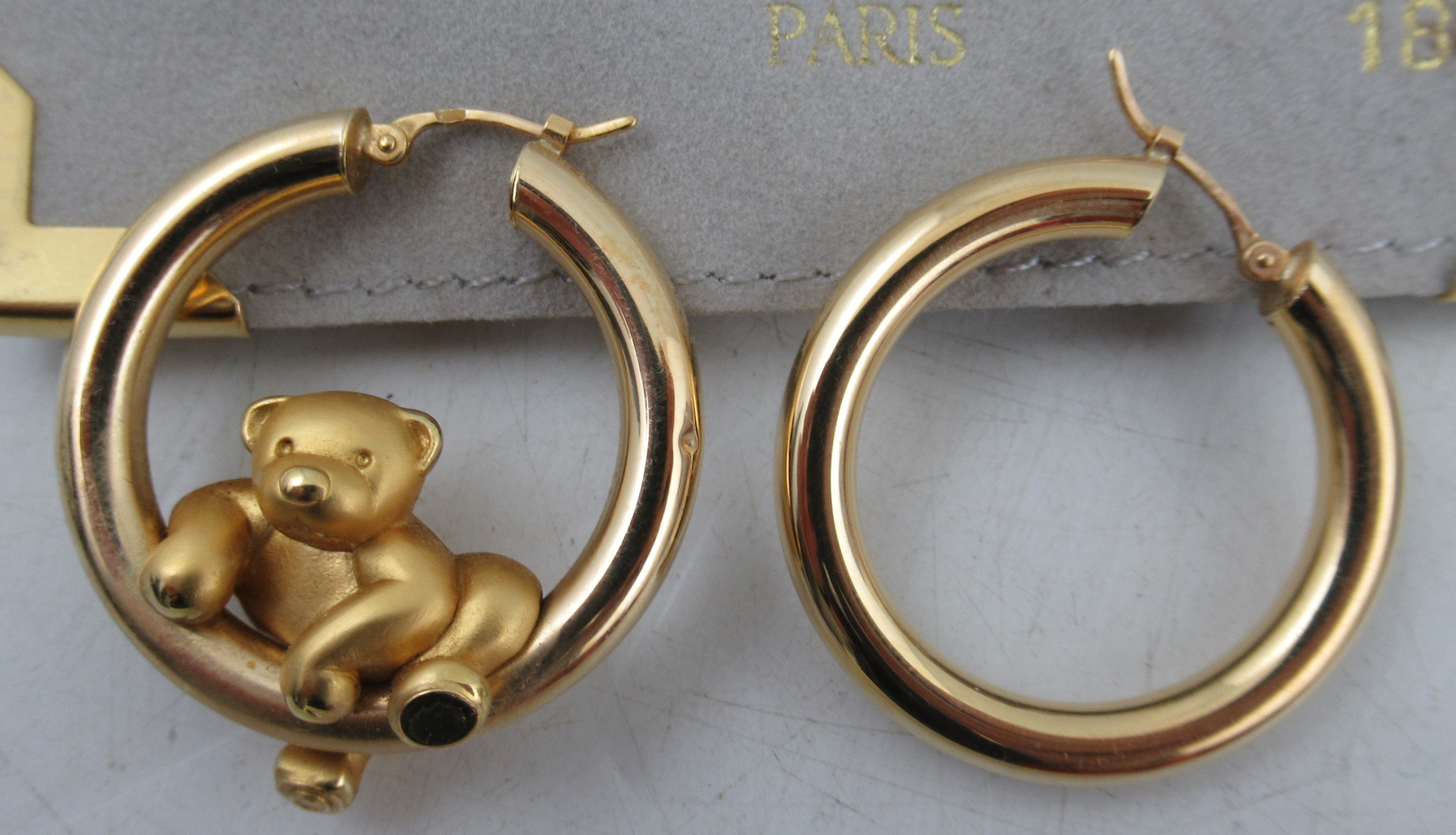 A pair of Charles Garnier 18ct gold hoop earrings, one with bear French ...