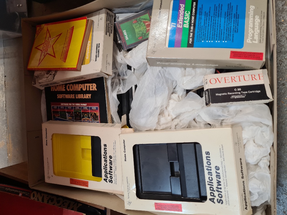 An old Texas Instruments computer Ti-99/4A with a quantity of ...