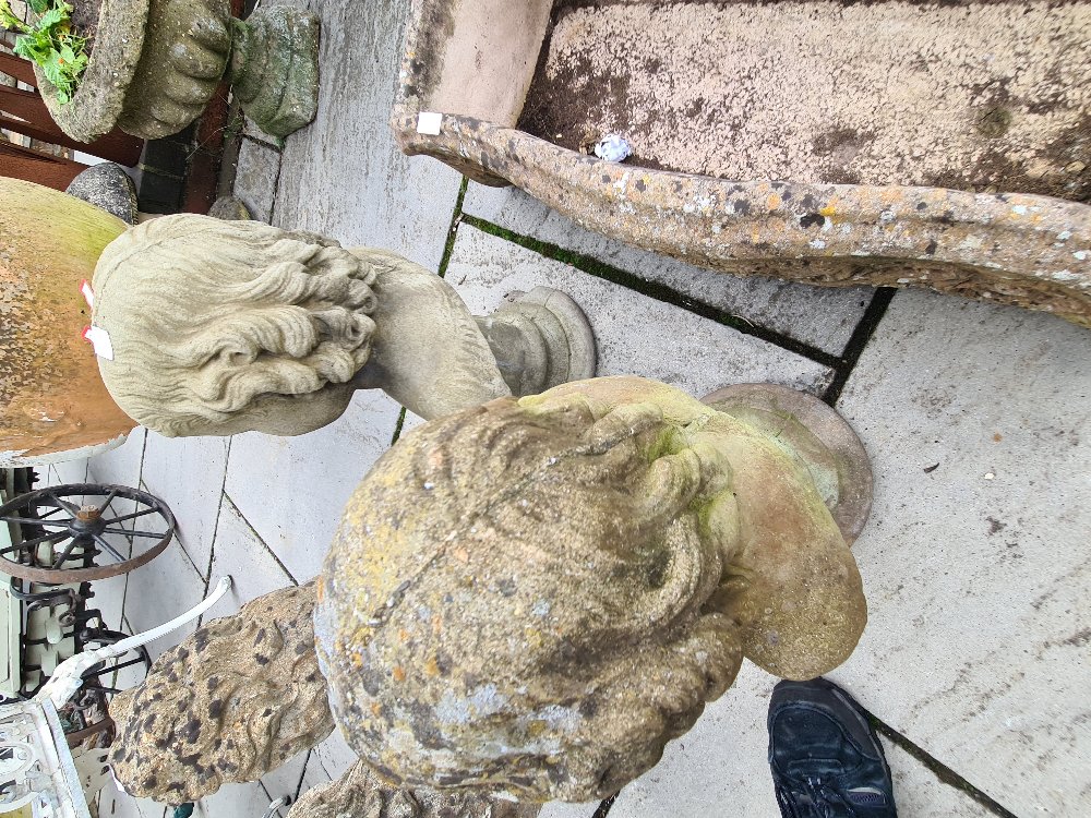 A pair of recon stone busts of children.