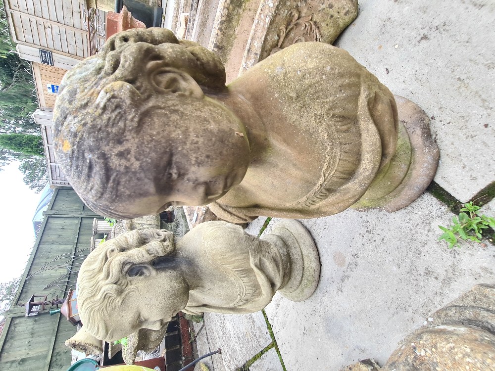A pair of recon stone busts of children.