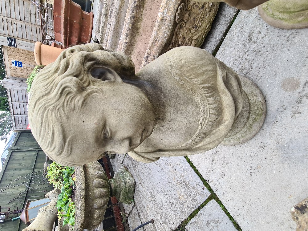 A pair of recon stone busts of children.